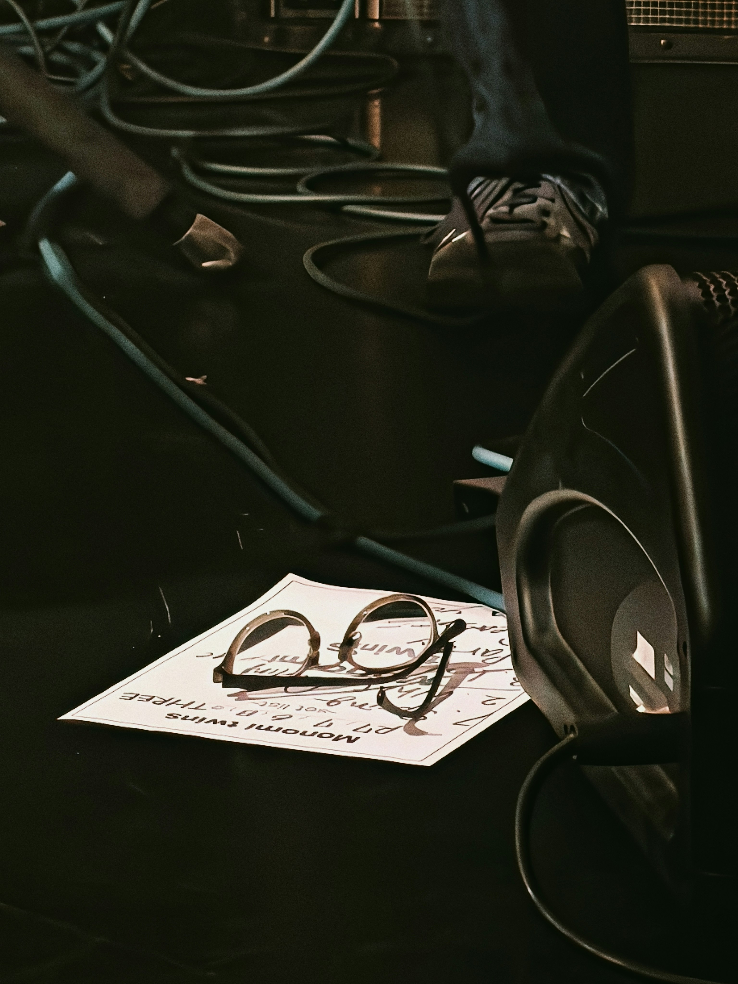Taking all the heat. | Glasses resting on sheet music with cables around