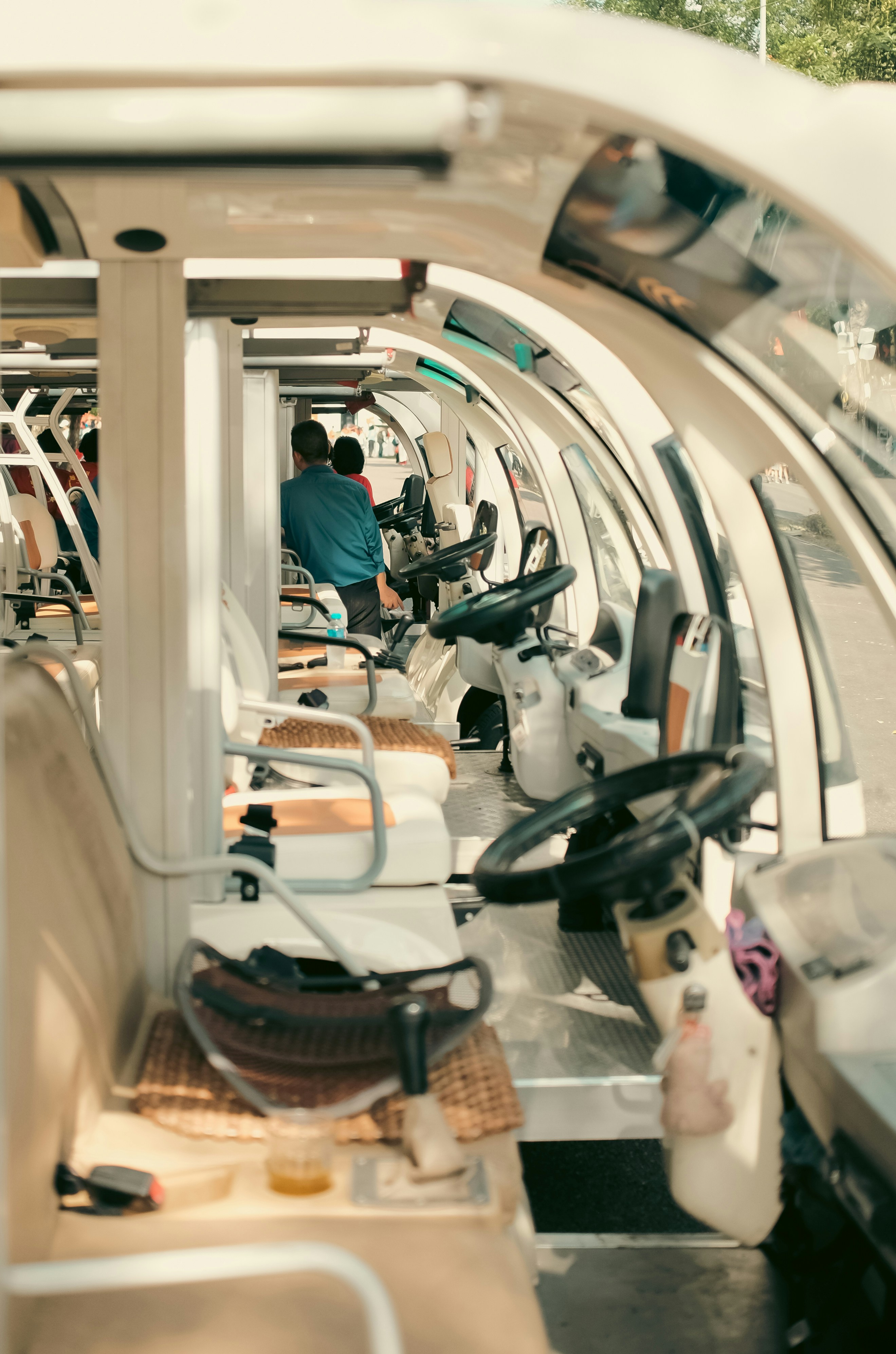People sitting inside a tour bus with clear roof