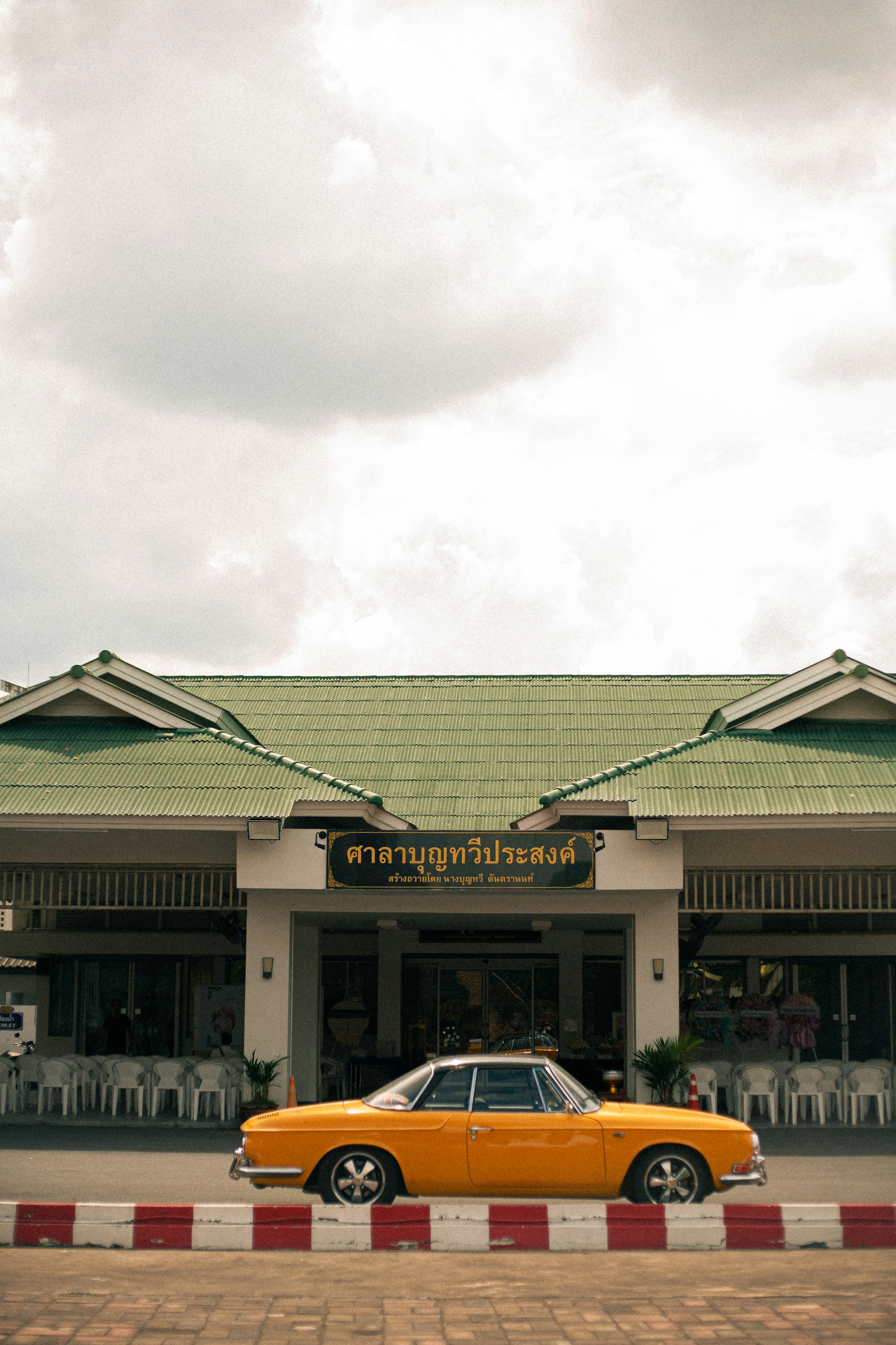 Yellow vintage car parked in front of building