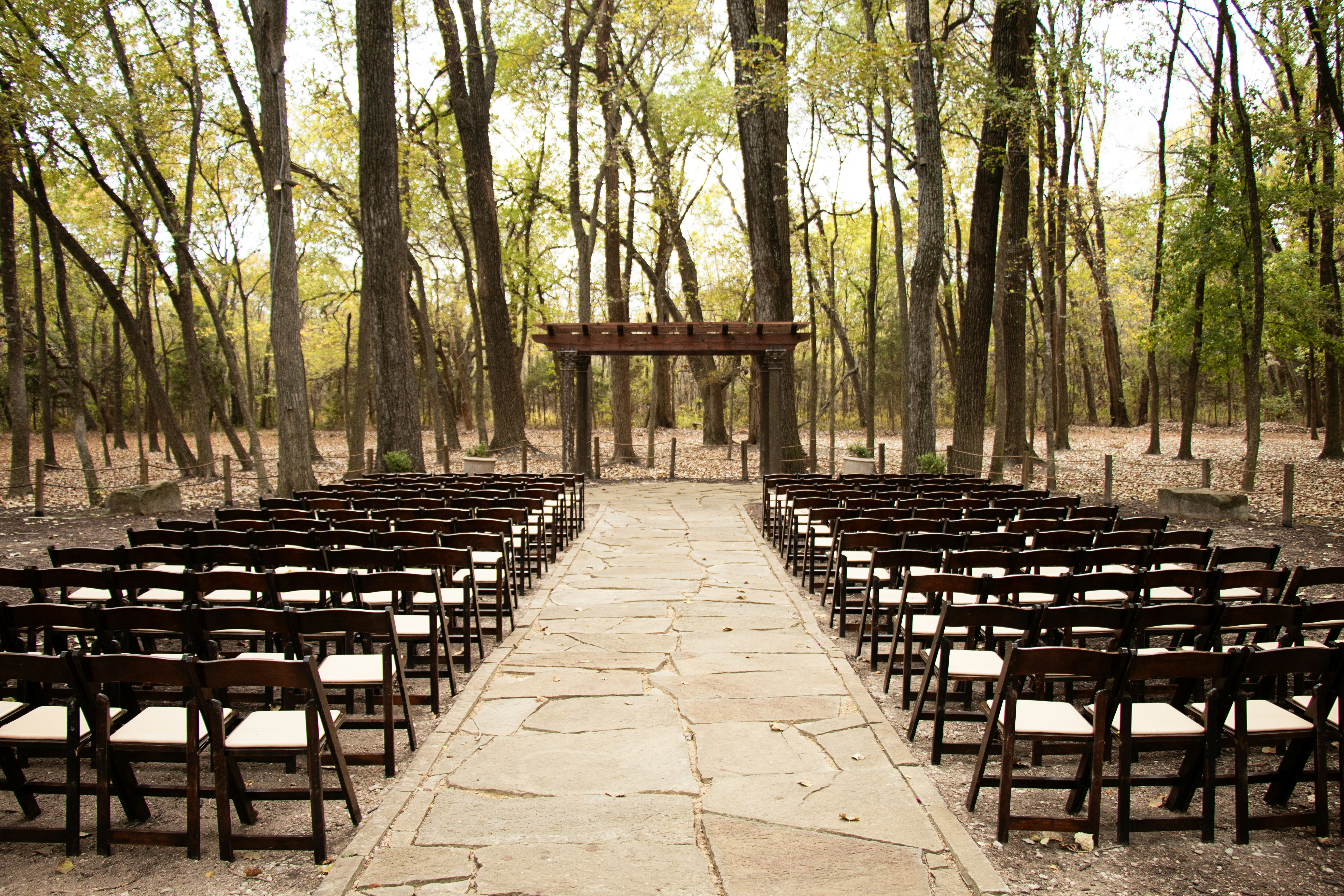 wedding, chairs, woods, trees, wedding venue | Outdoor wedding ceremony setup in a forest clearing