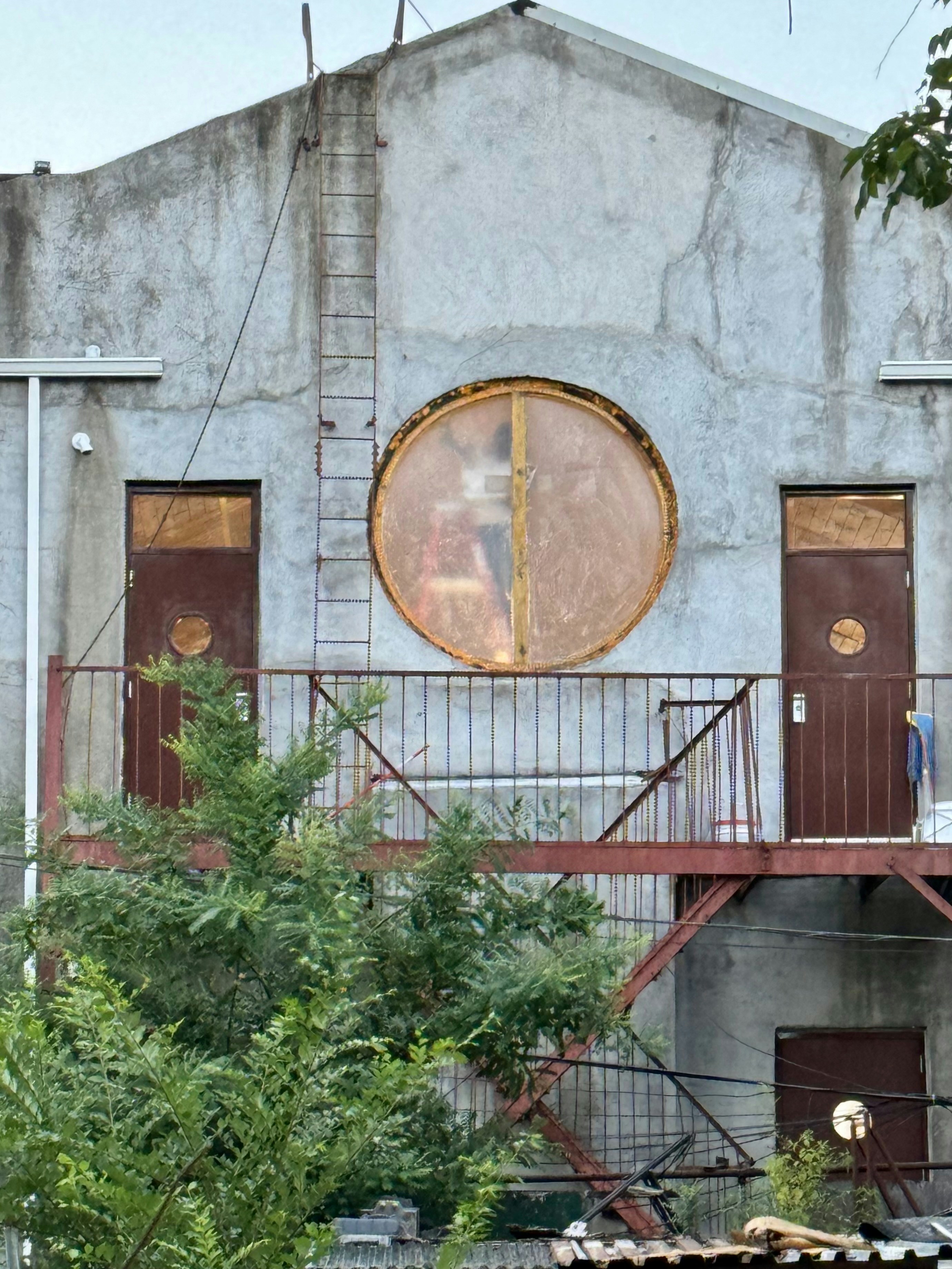 Building with circular window and two doors