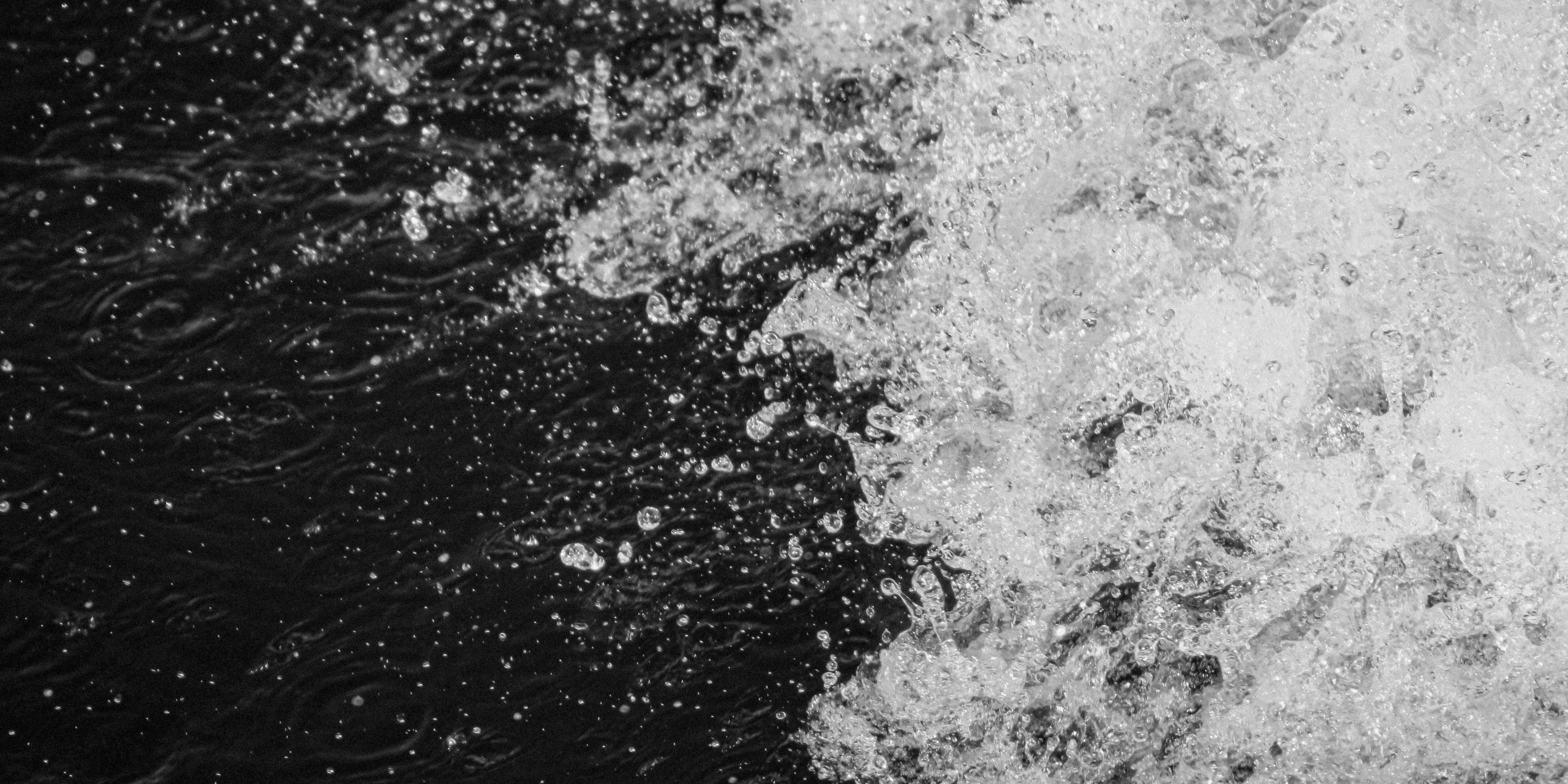 black and white splashing water in deep lake | Abstract splash of water against dark background
