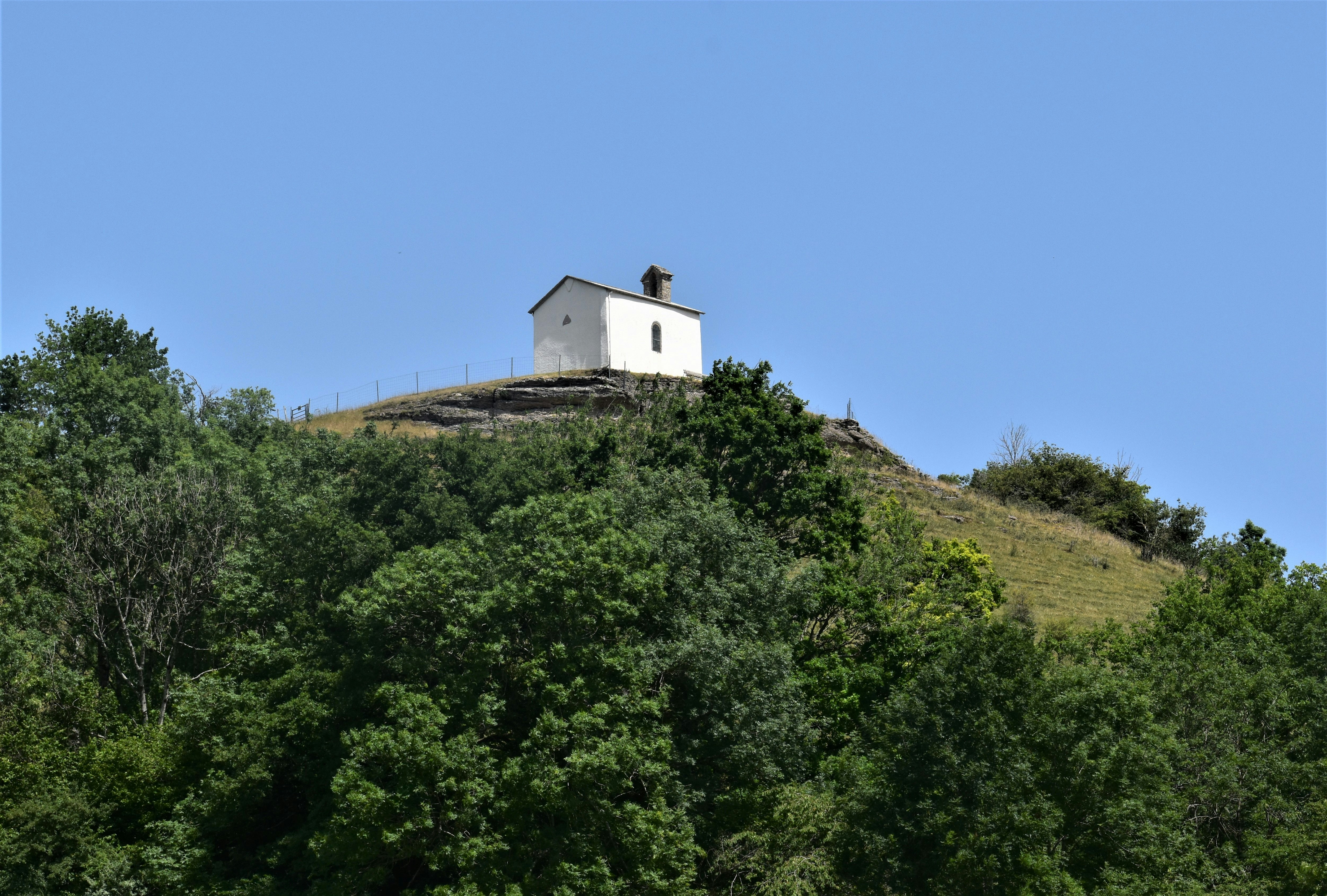 Small Church | Small white chapel on a grassy hilltop.