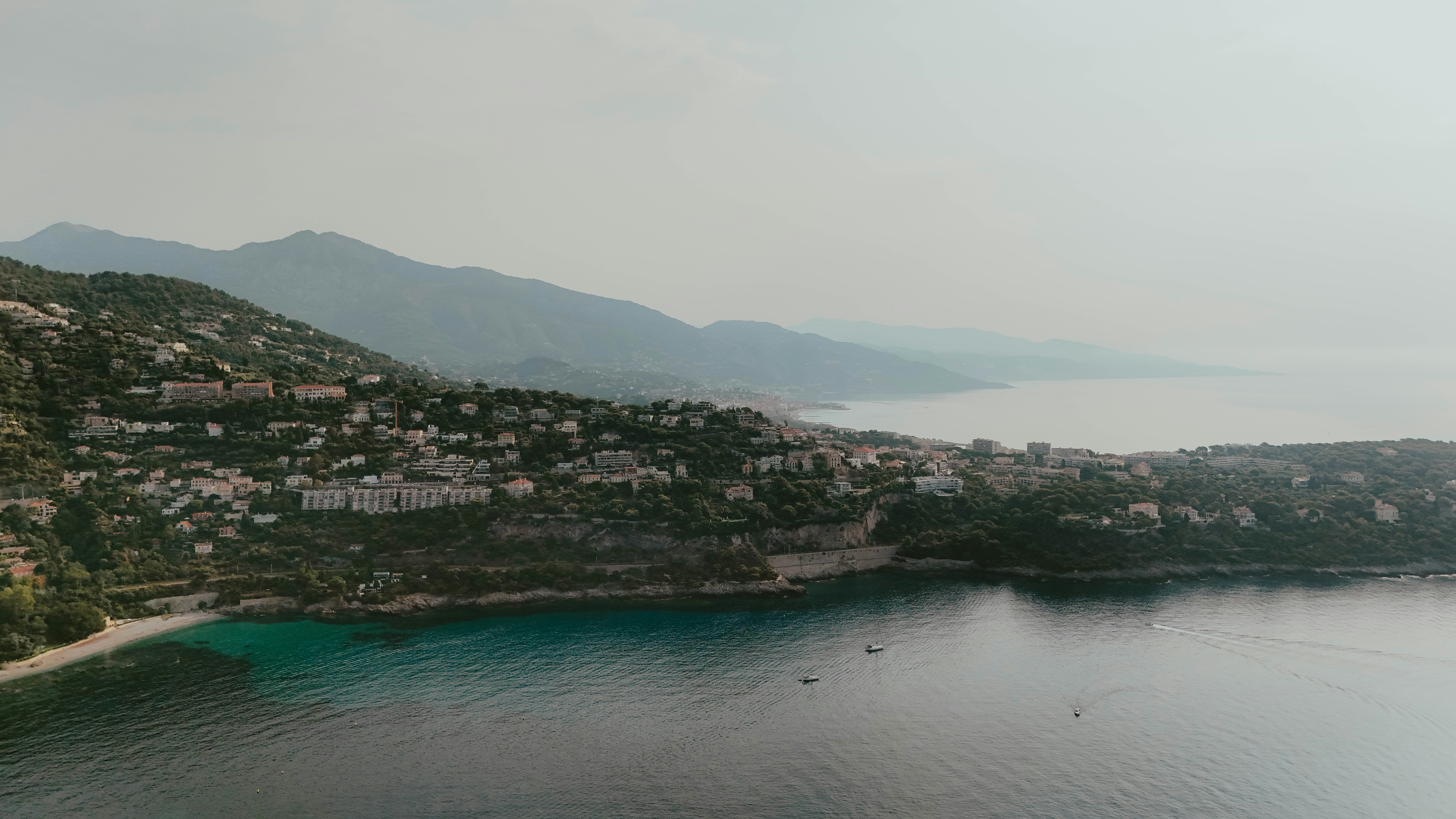 Coastal town nestled on a hillside overlooking the ocean.