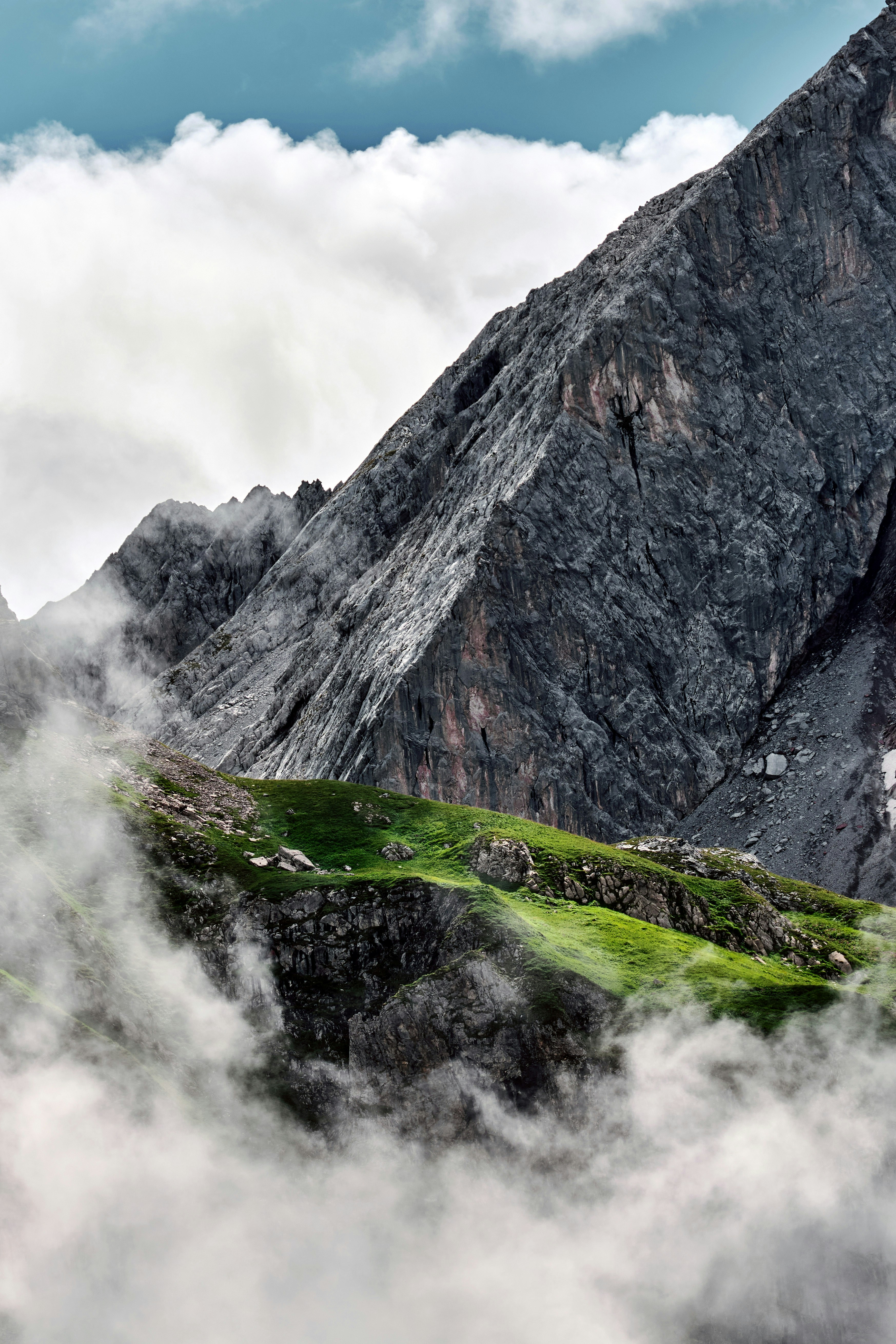 Jagged mountain peak emerges from misty clouds