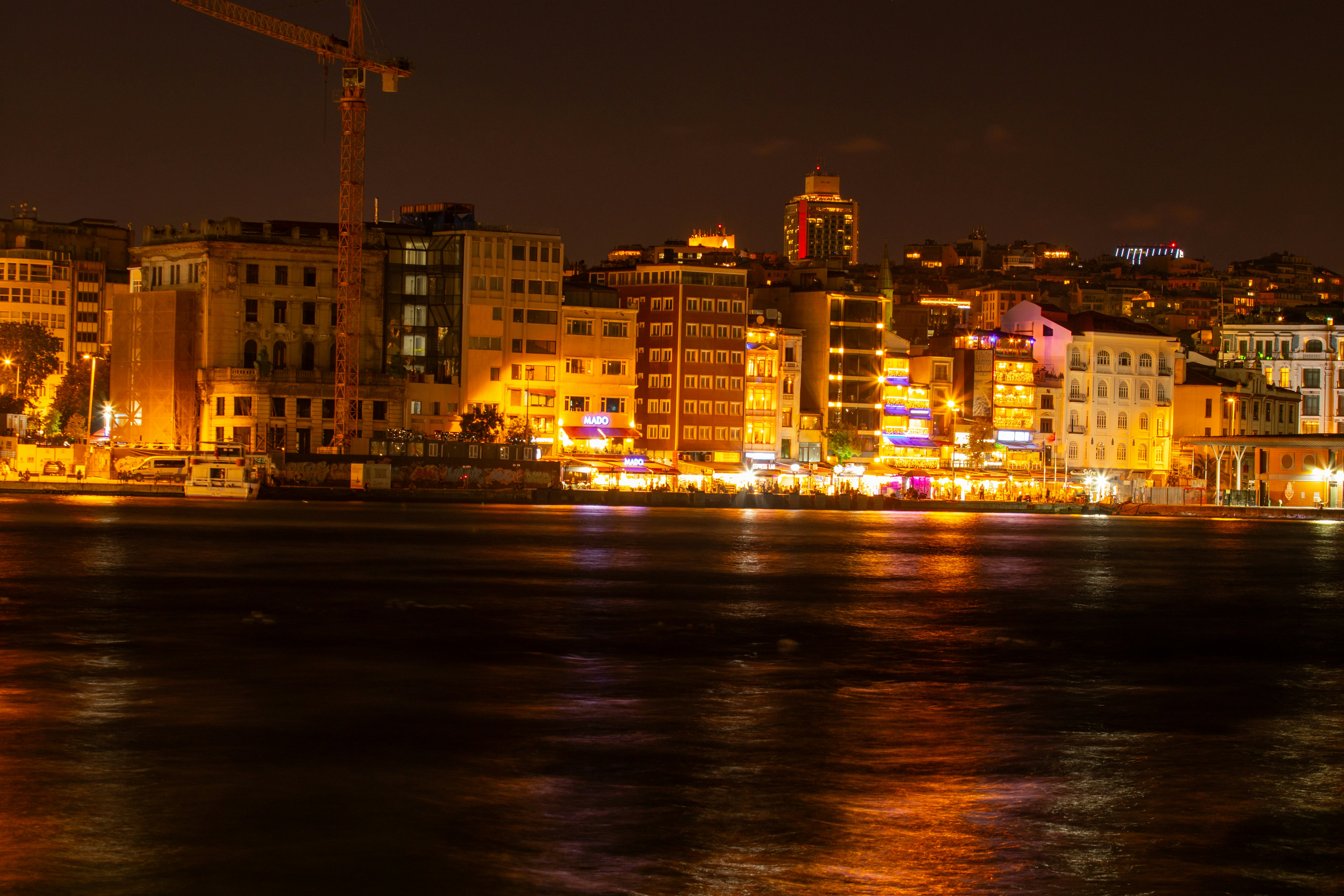 Nocturnal Reflections: Urban Serenity by the Water