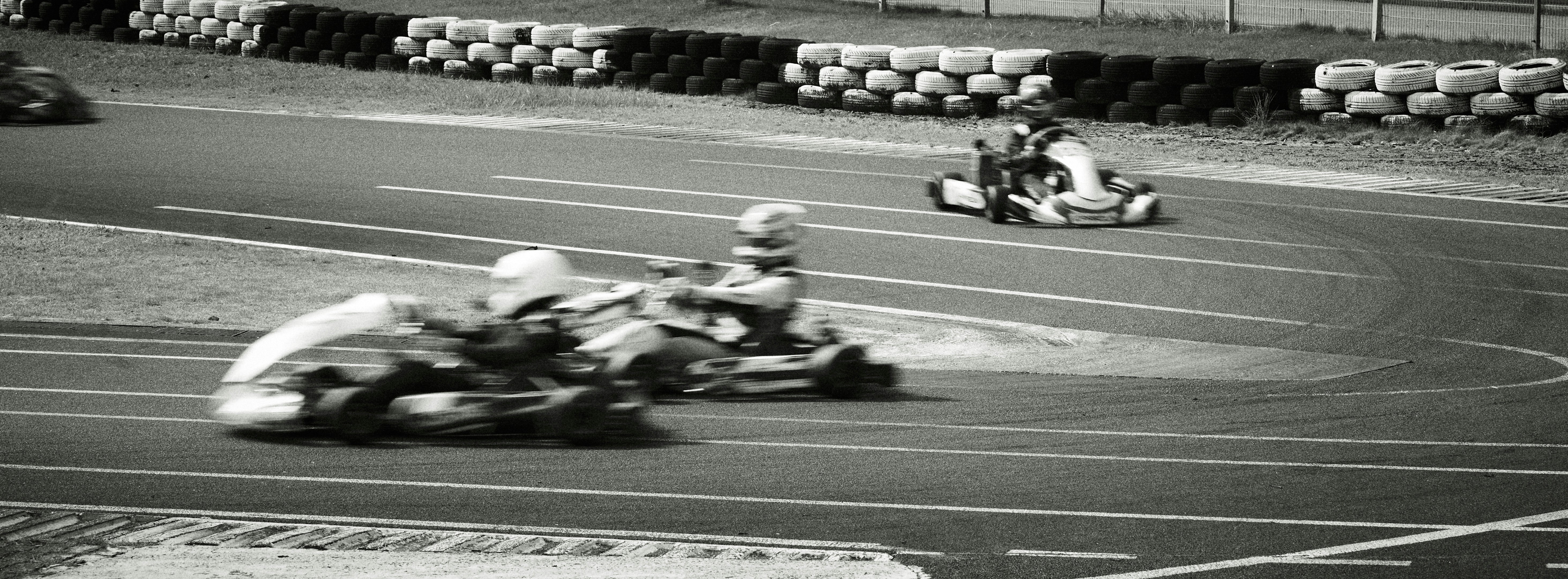Blurred Sprint: Karts Drifting Through a Race Line