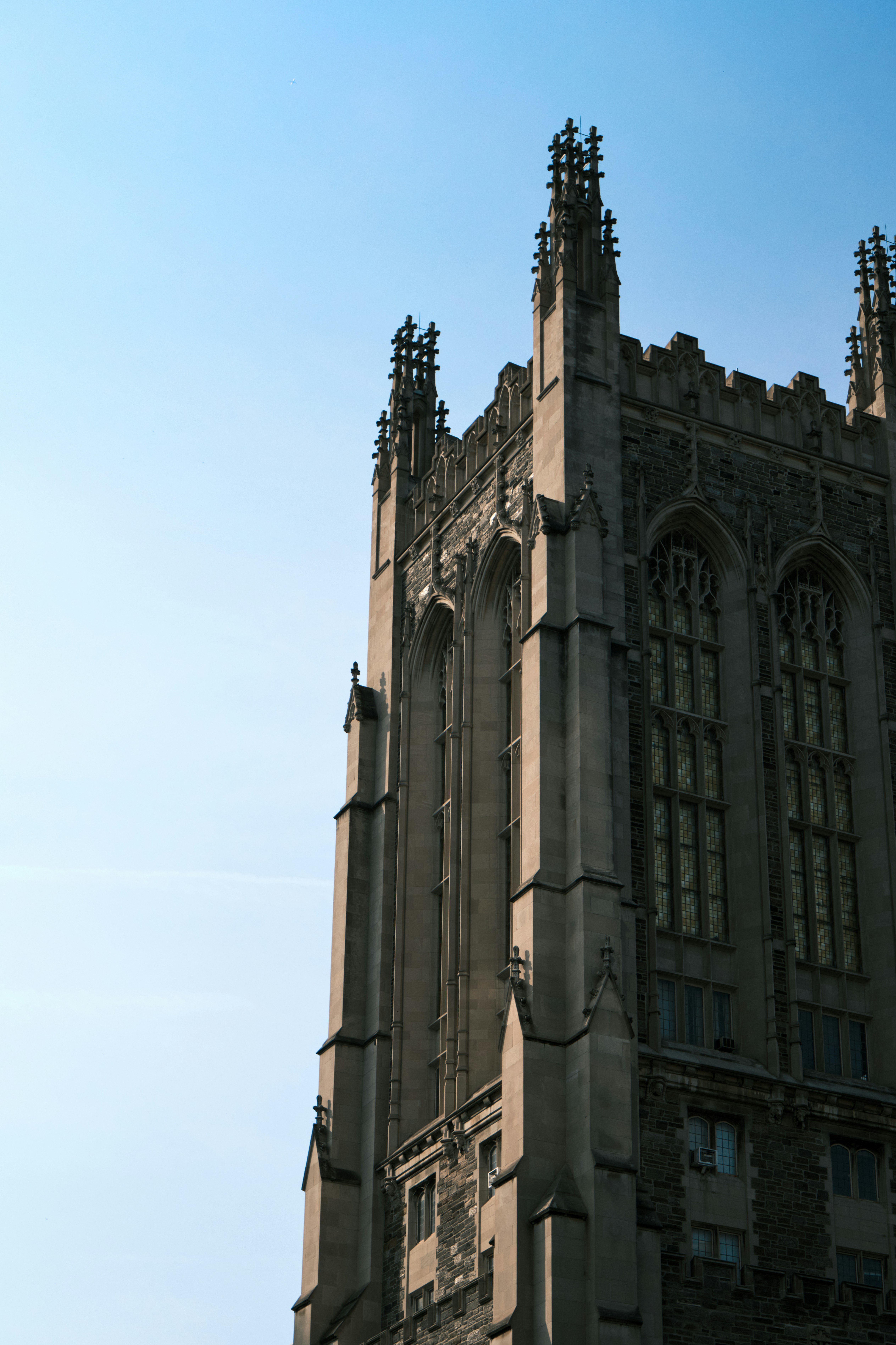 Gothic architecture tower against a clear blue sky
