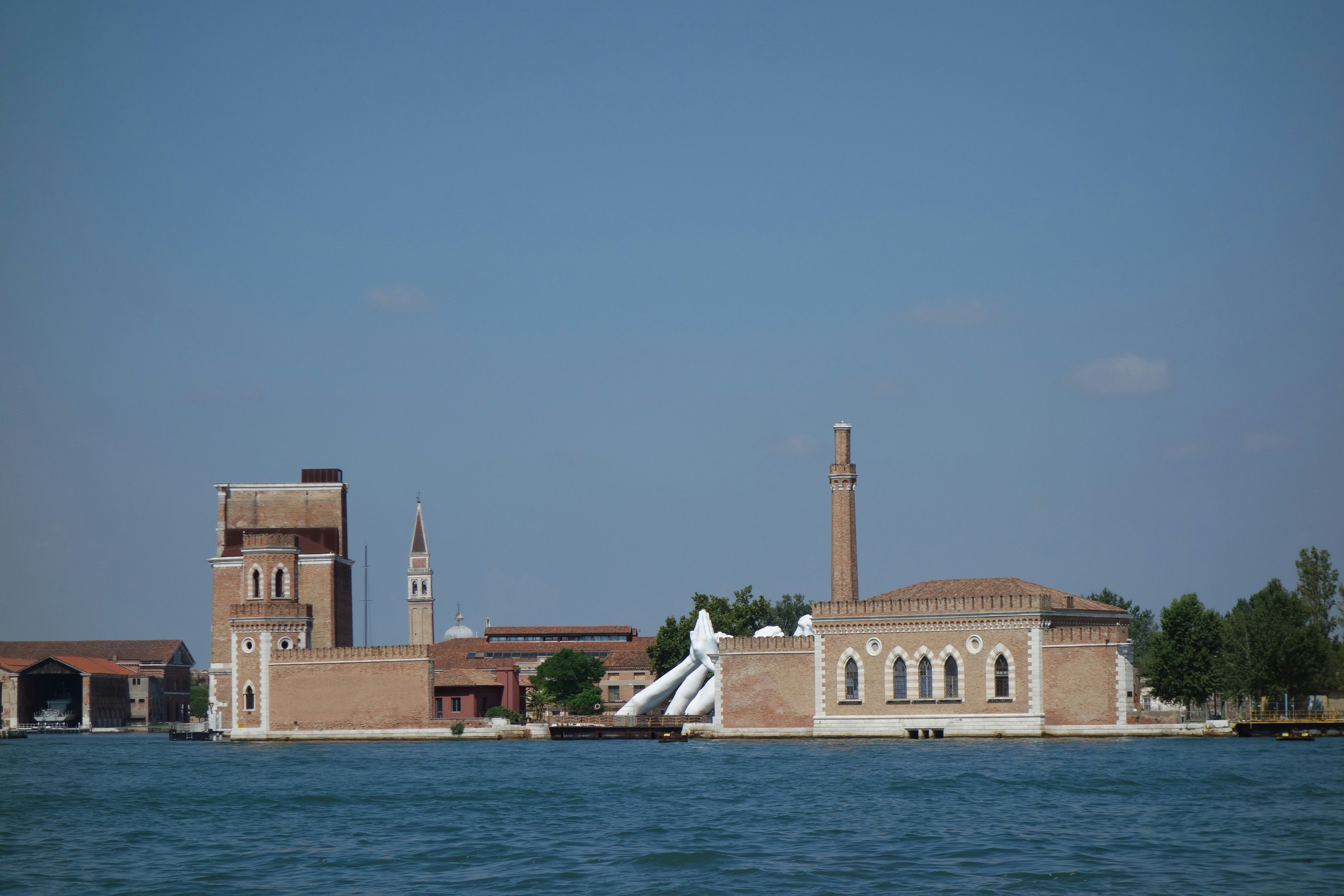 Buildings with a tall chimney on the water
