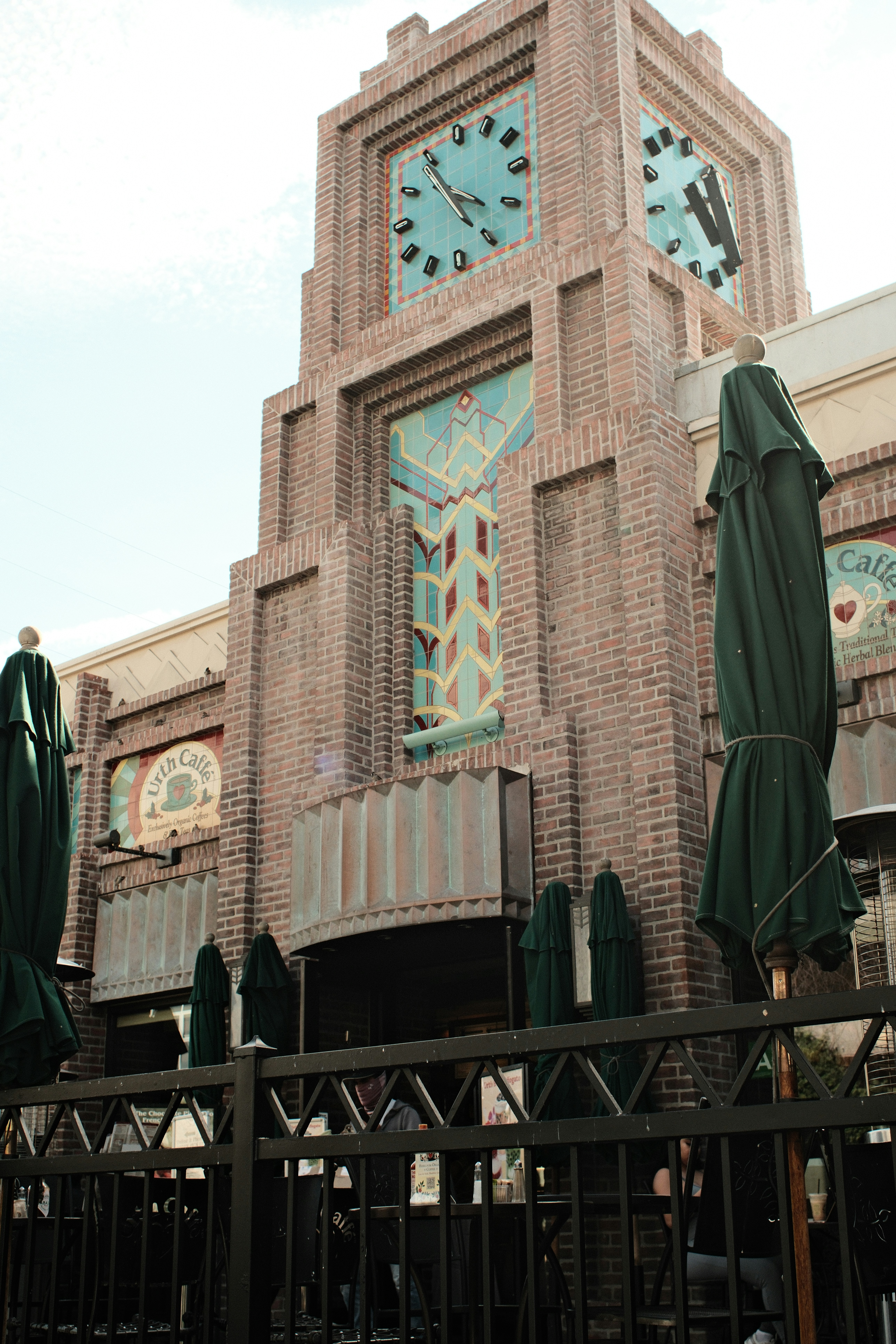 Art deco building with a clock tower and umbrellas