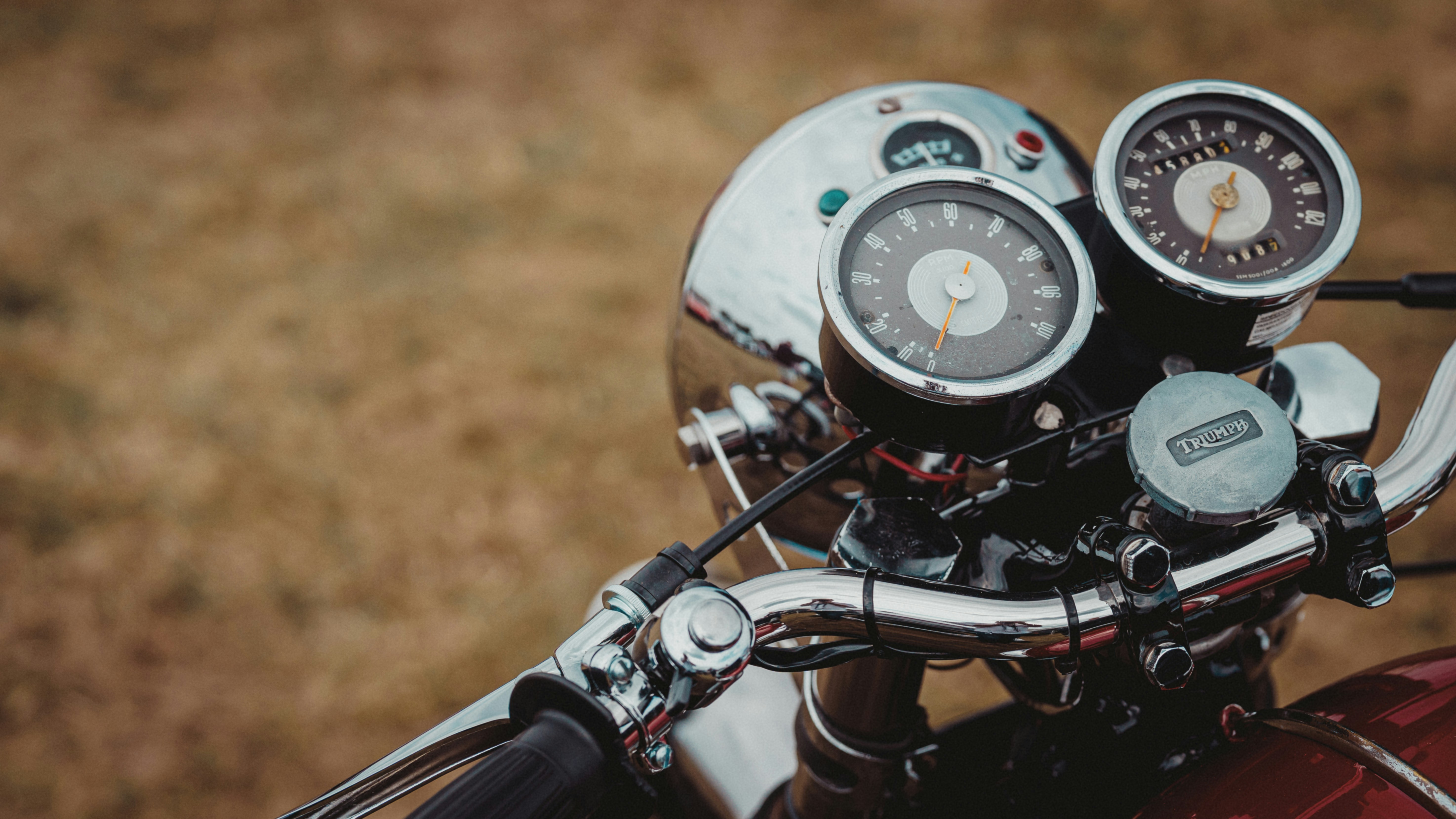 Close-up of vintage motorcycle handlebars and gauges