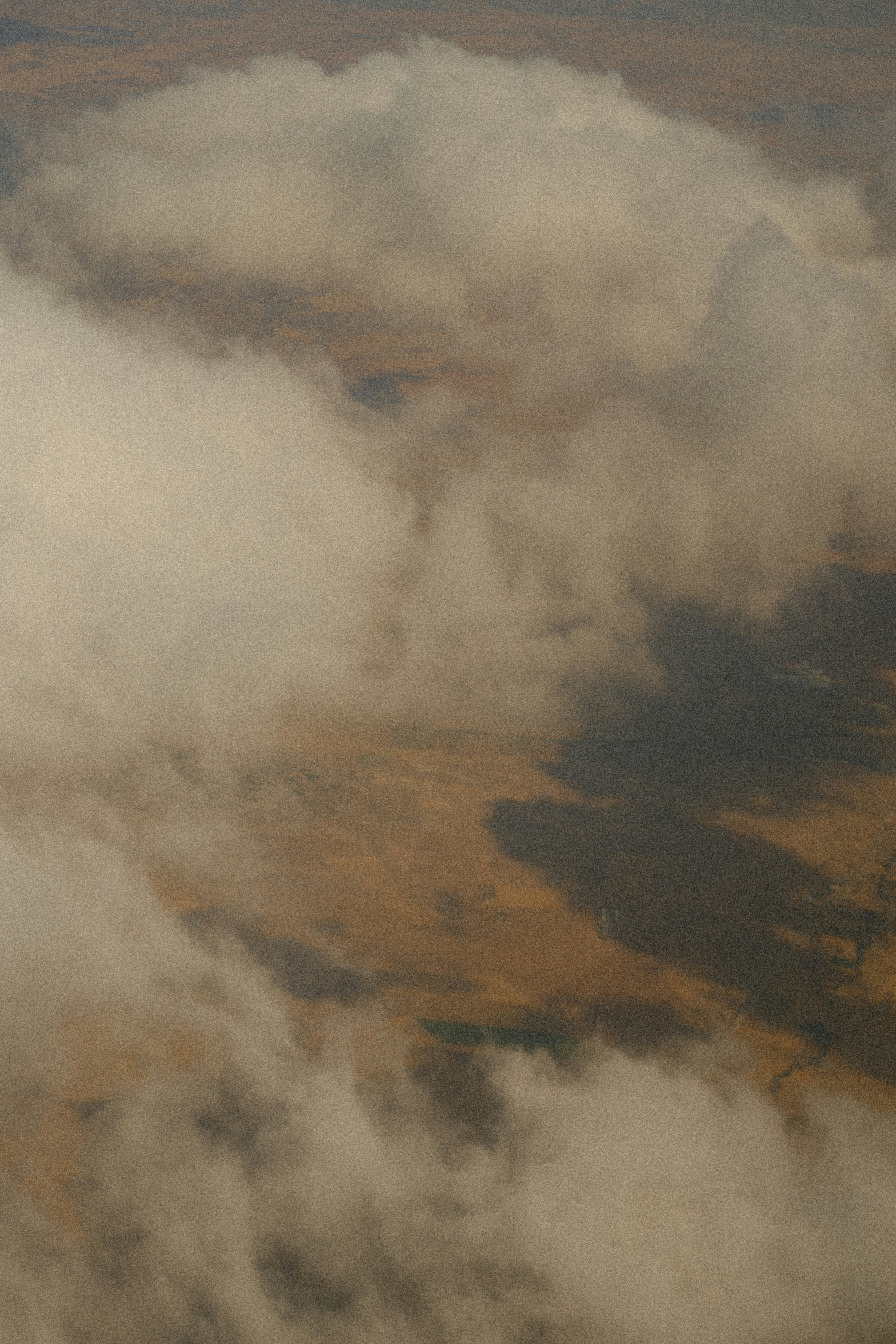 Clouds drifting over a dry, tan landscape.