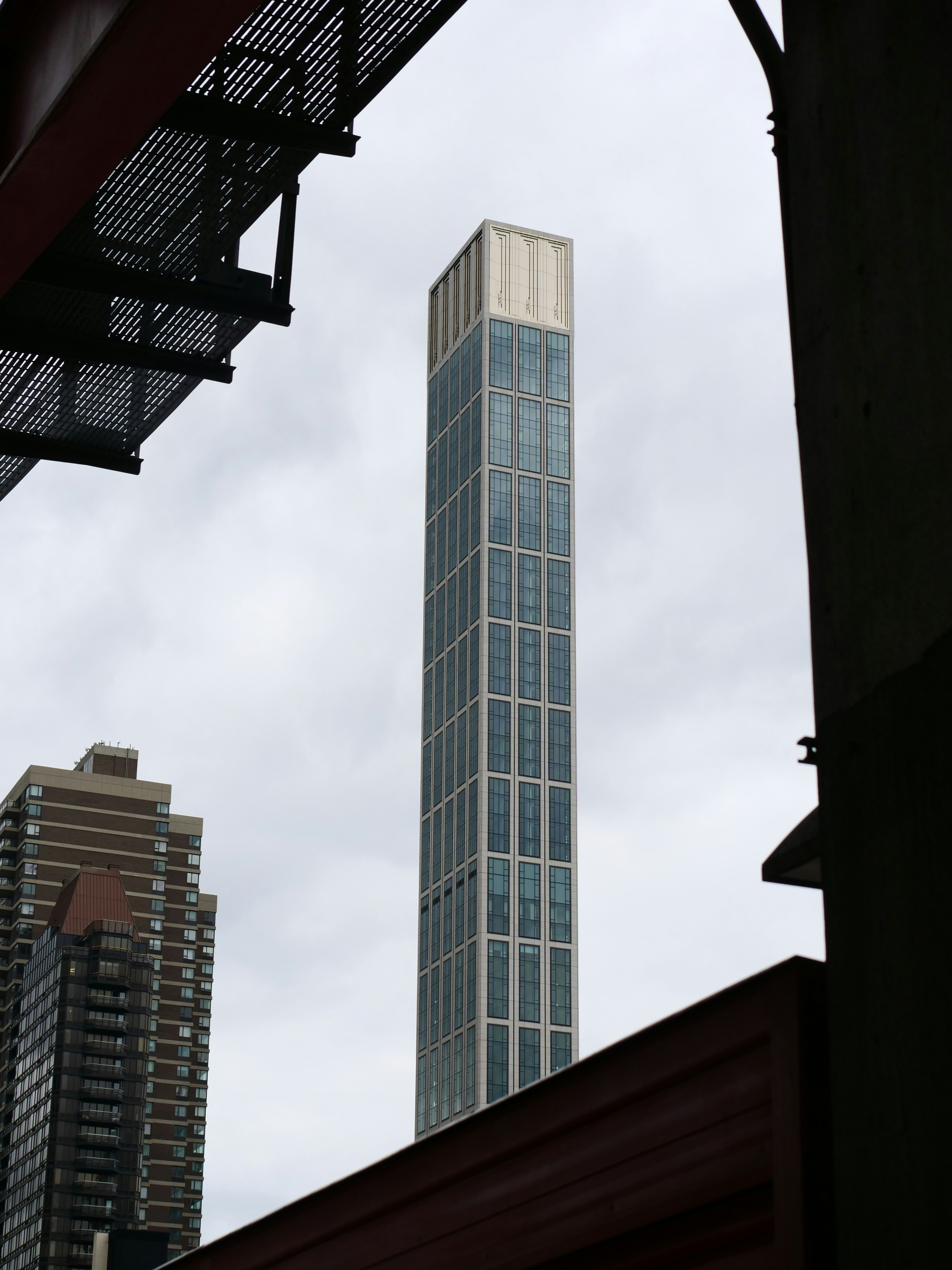 Tall modern skyscraper framed by buildings