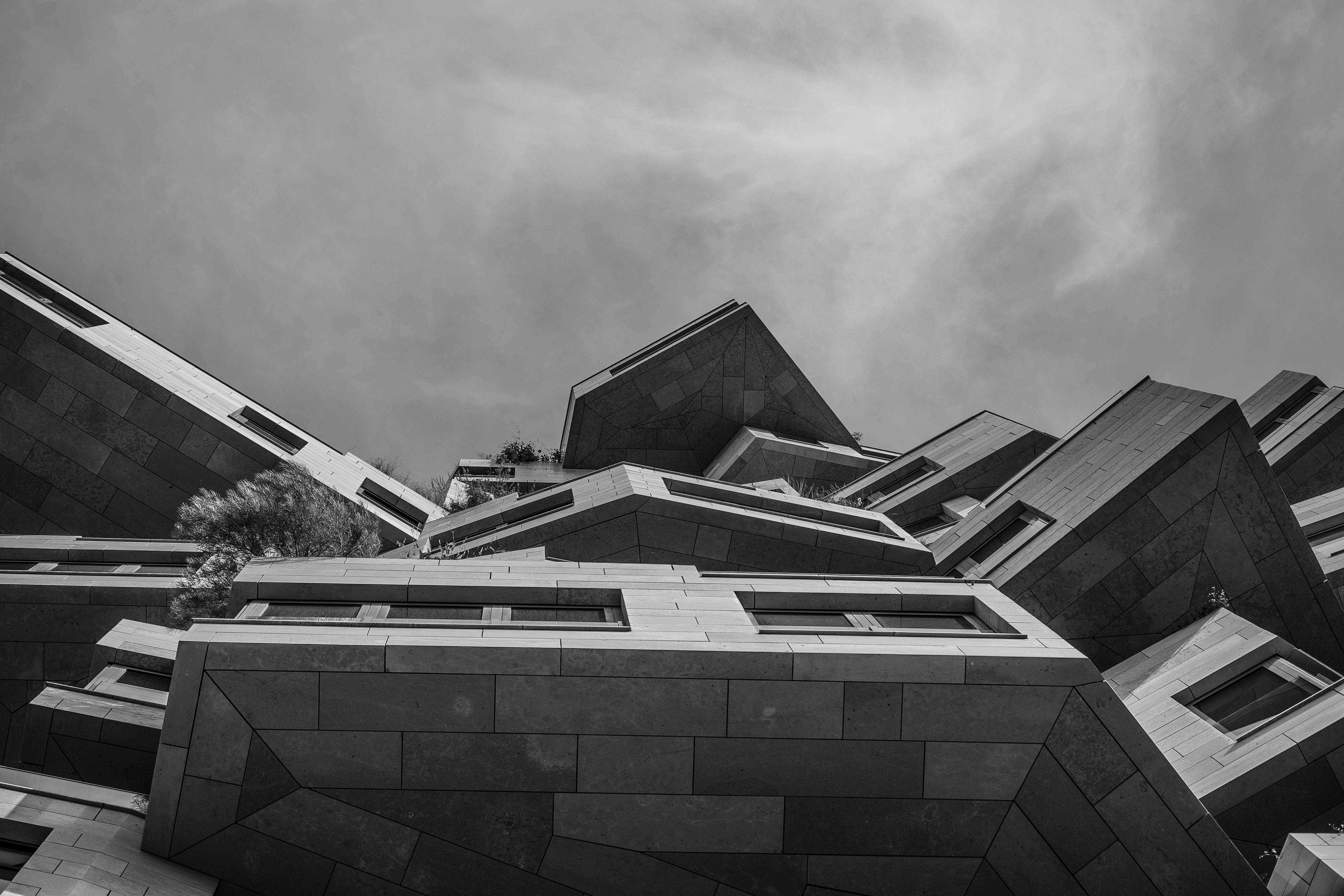 The Valley, Amsterdam | Modern building with angular geometric design against cloudy sky