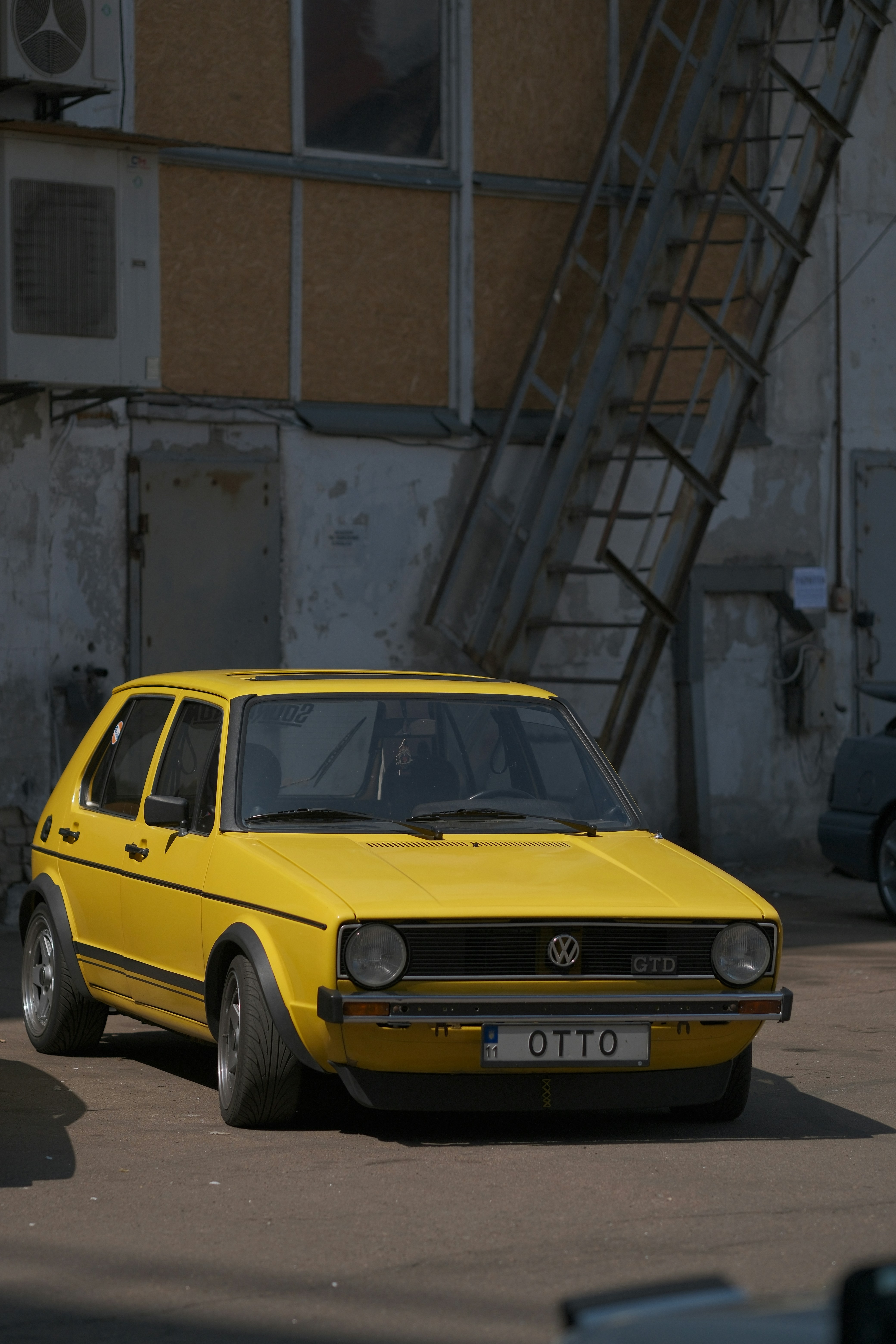 Yellow volkswagen golf gti parked outside building photo – Free Car ...