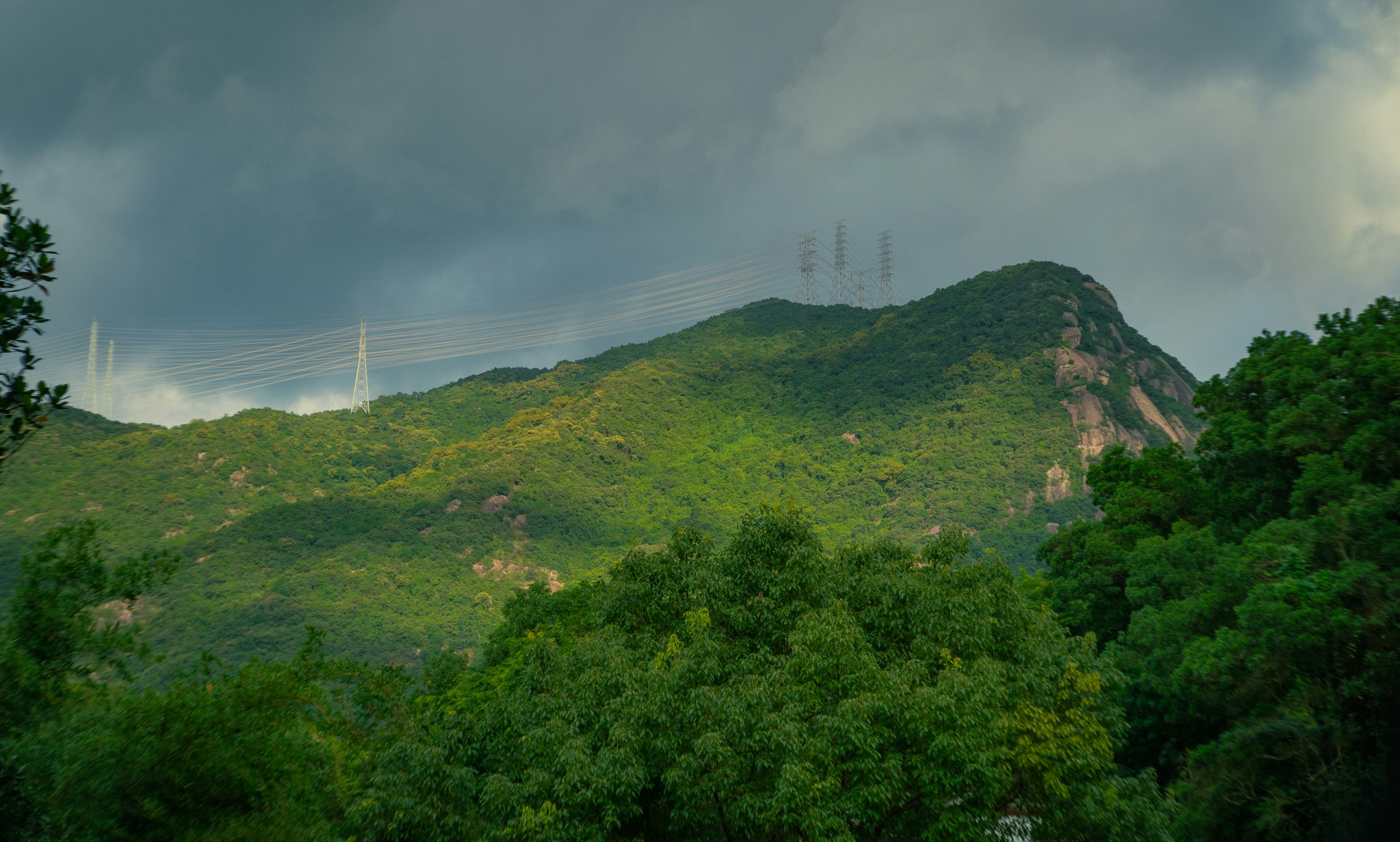 OLYMPUS DIGITAL CAMERA | Lush green mountain landscape with dramatic clouds