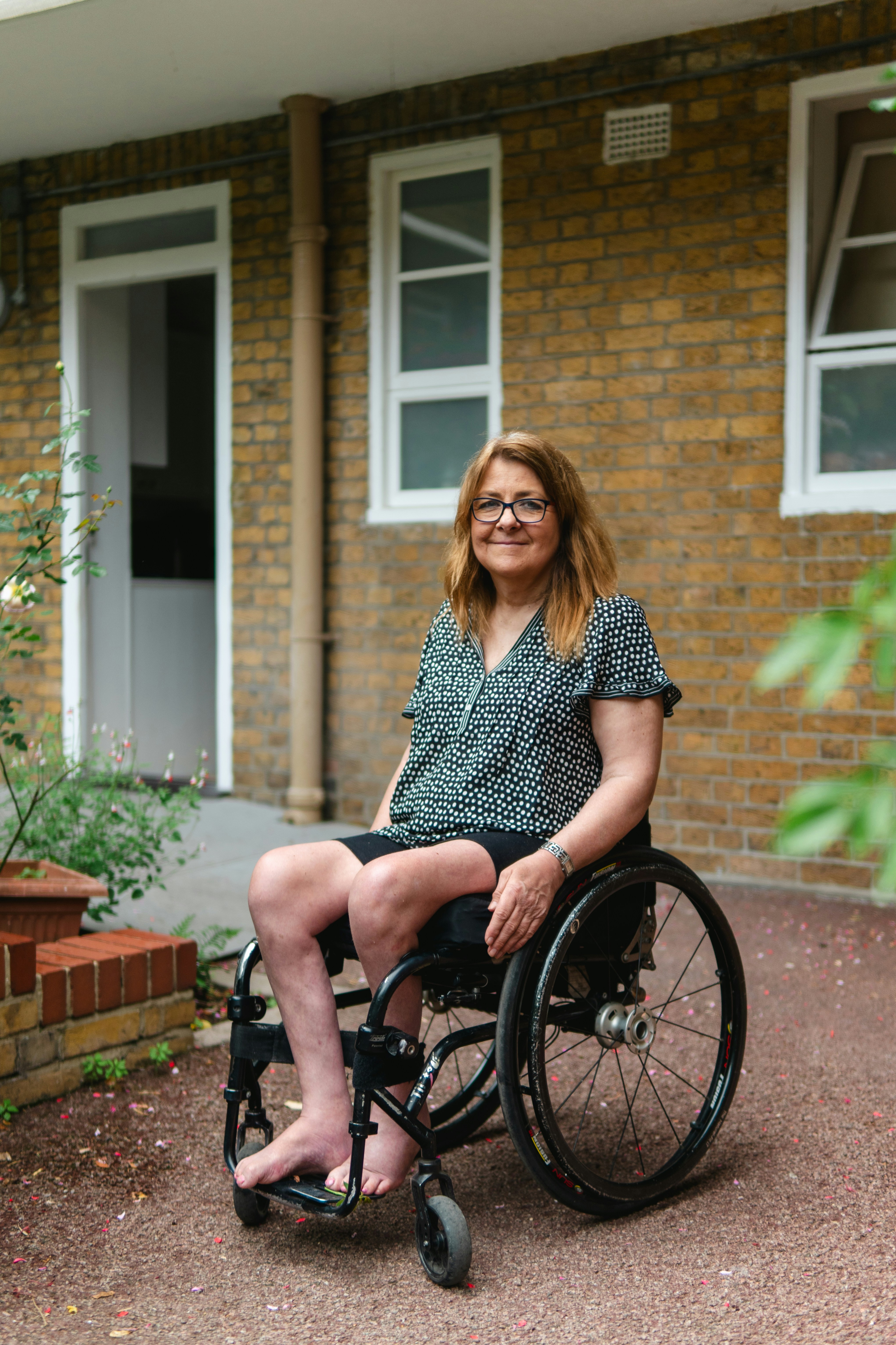 Porch Light Portrait: Confidence and Calm by a Brick Home