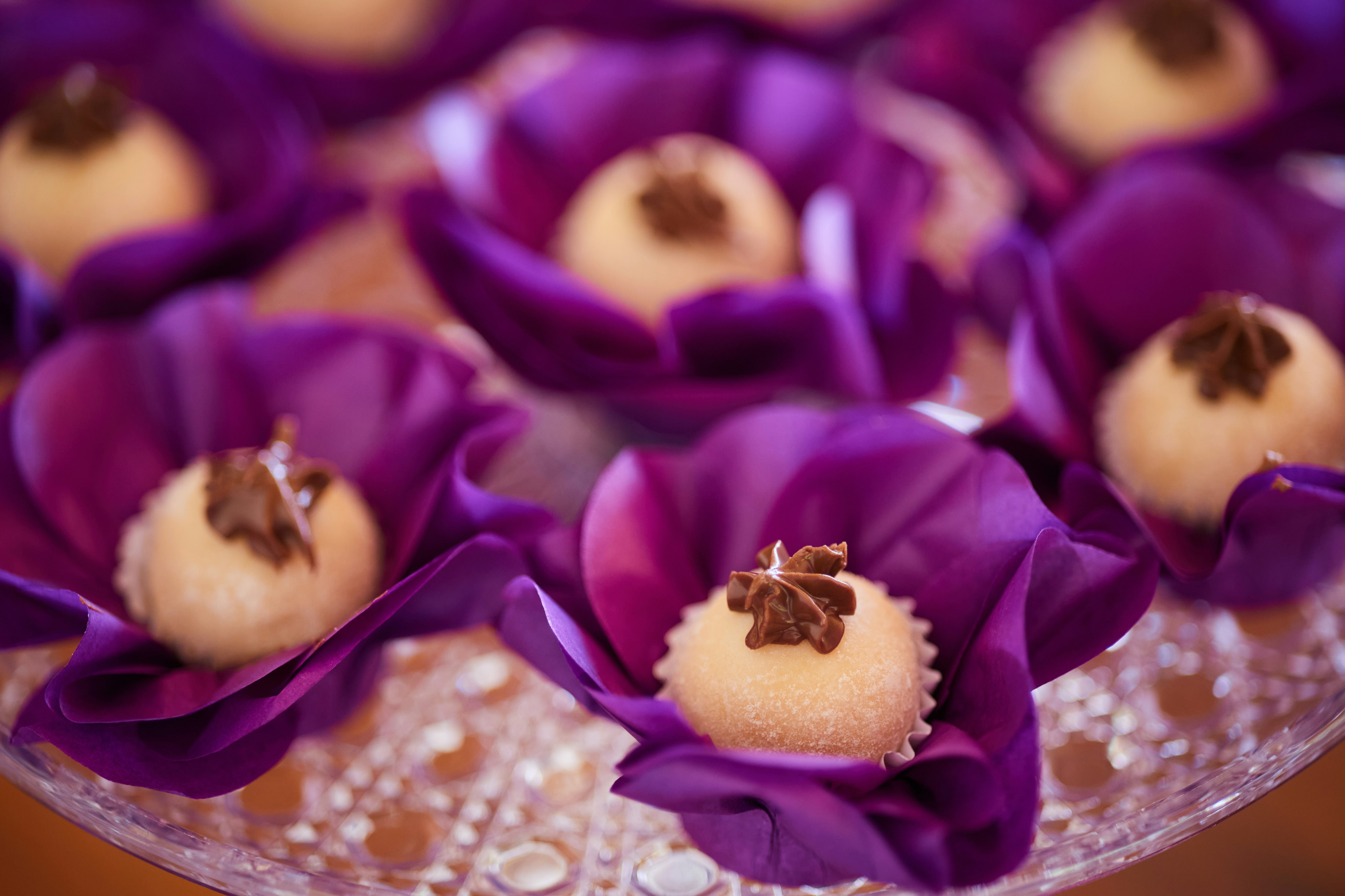 Violet Petal Cups Cradling Golden Bites in a Crystal Tray
