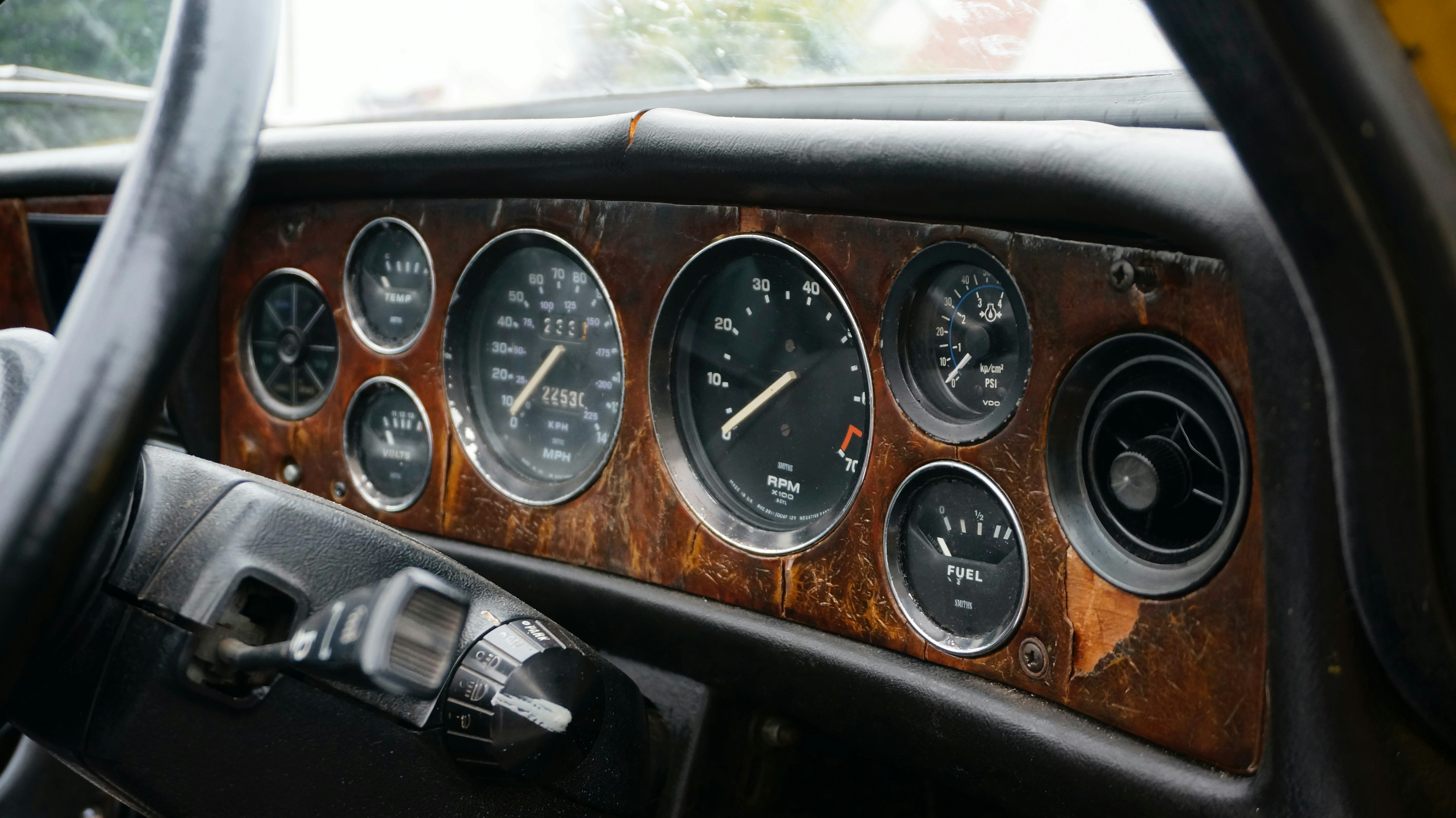 Detailed view of a classic car dashboard featuring vintage gauges and controls, showcasing the craftsmanship of its era.