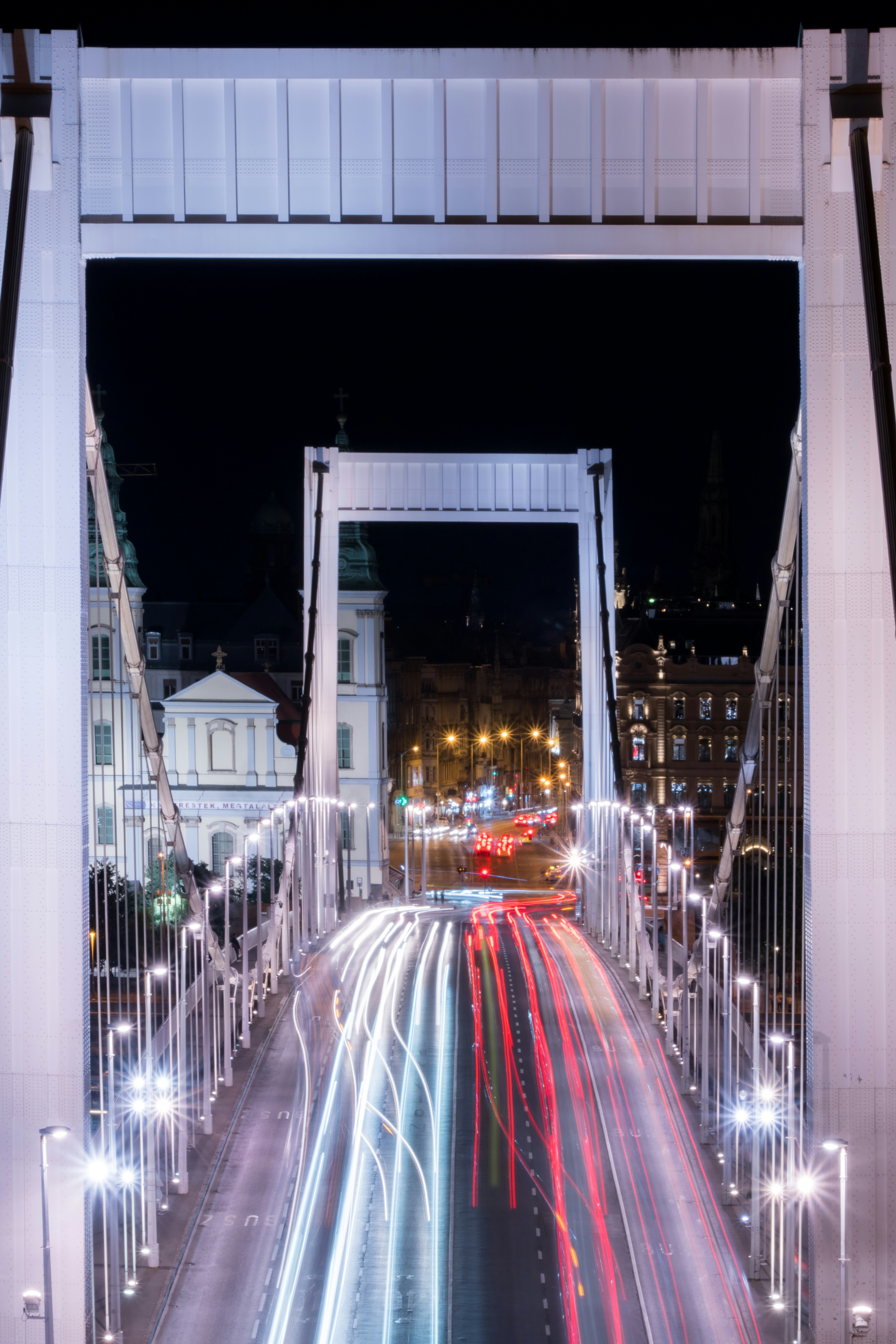 The Elizabeth Bridge of Budapest in the night under long exposure. | Light trails on a bridge at night