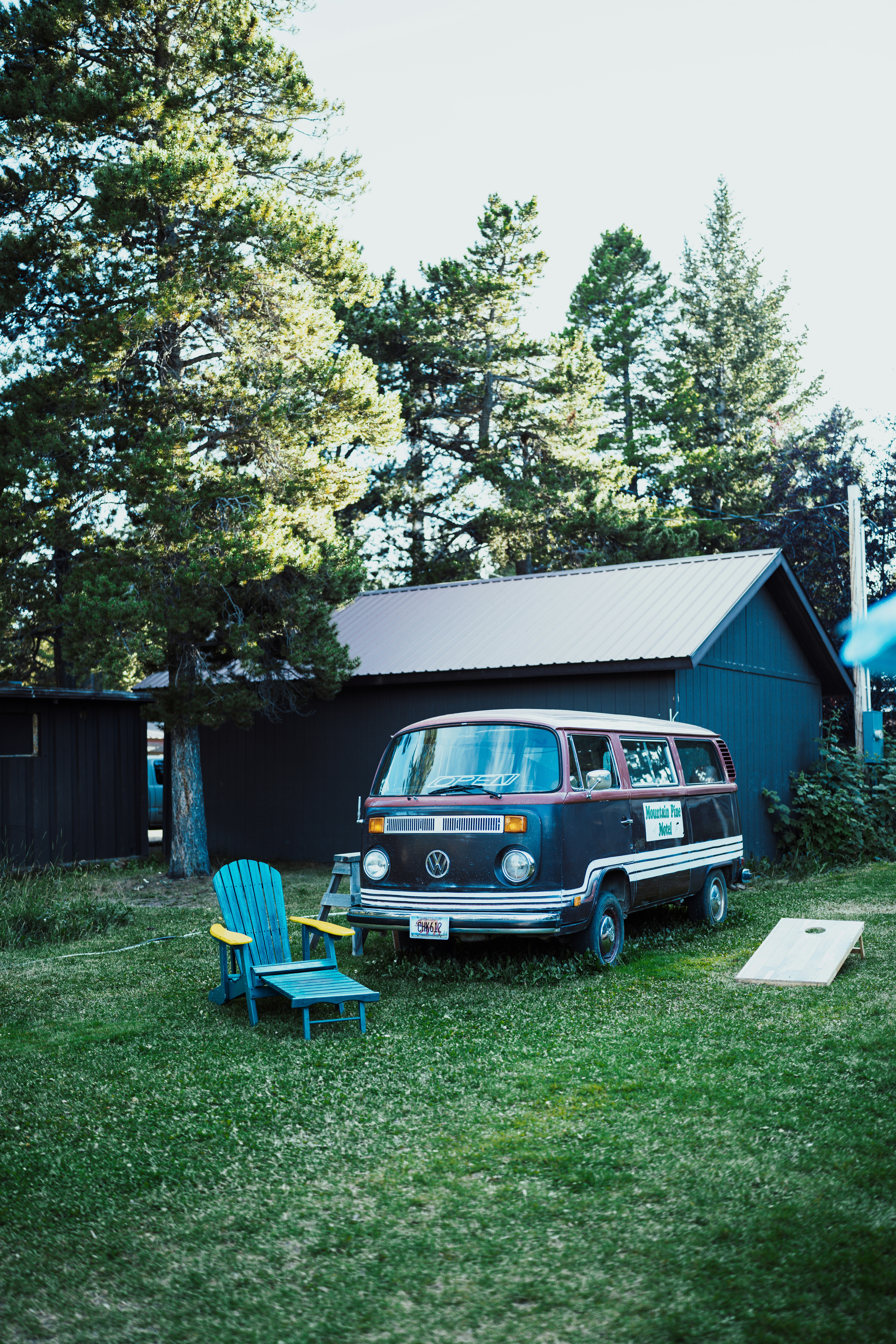 Vintage van parked near a building with chairs