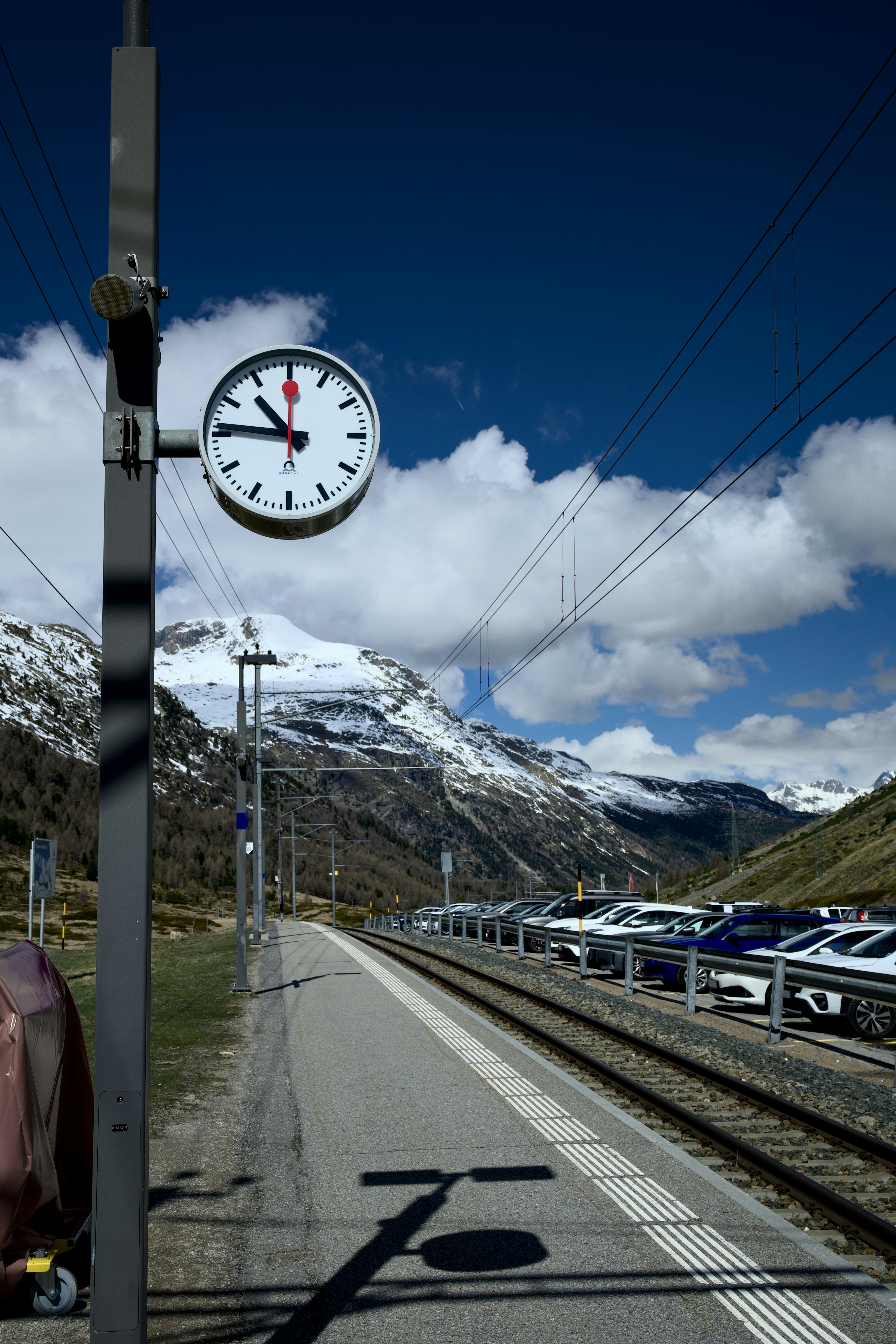 Train station clock with snowy mountains and blue sky photo – Free Car ...