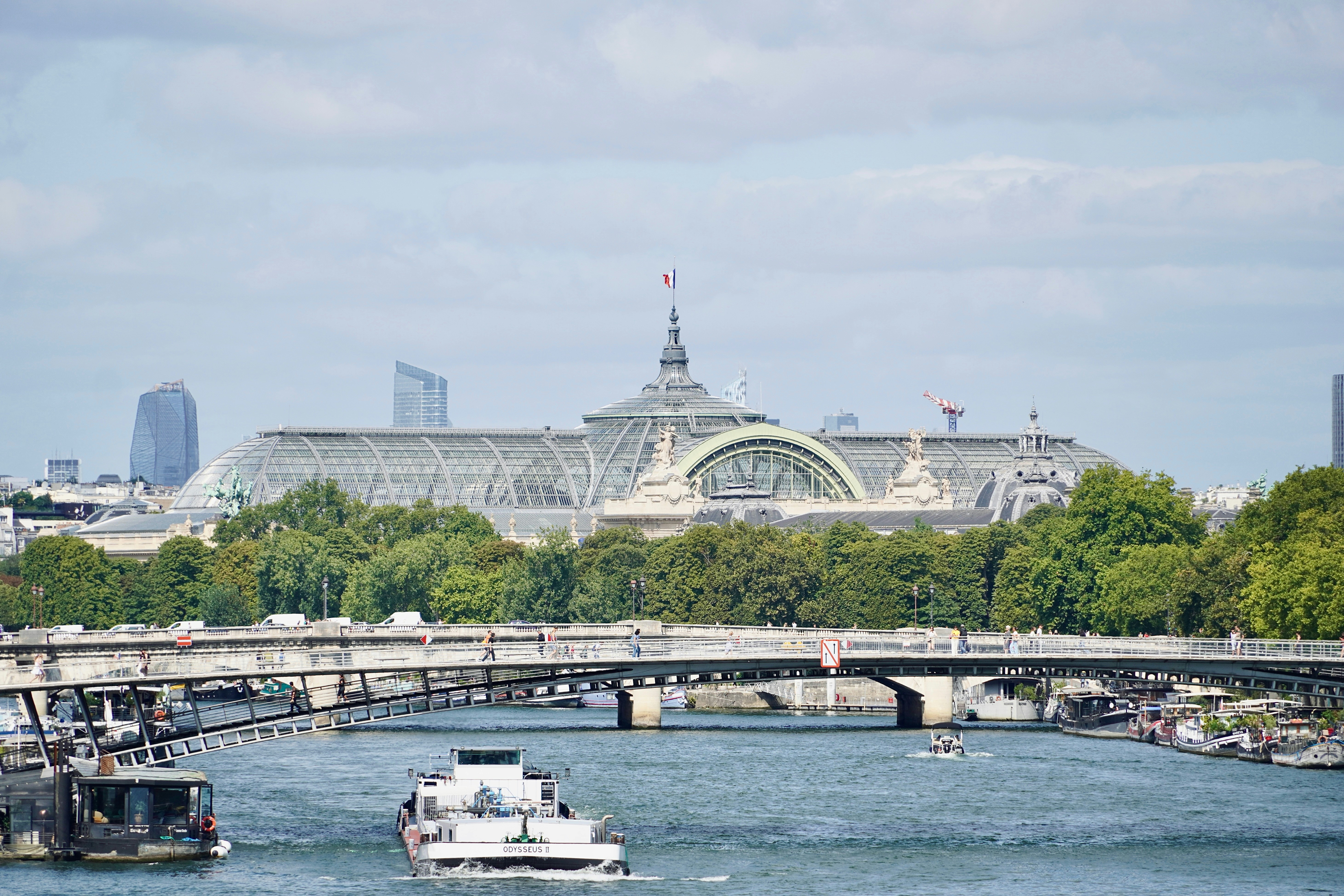 Boats on the seine river with grand palais building.