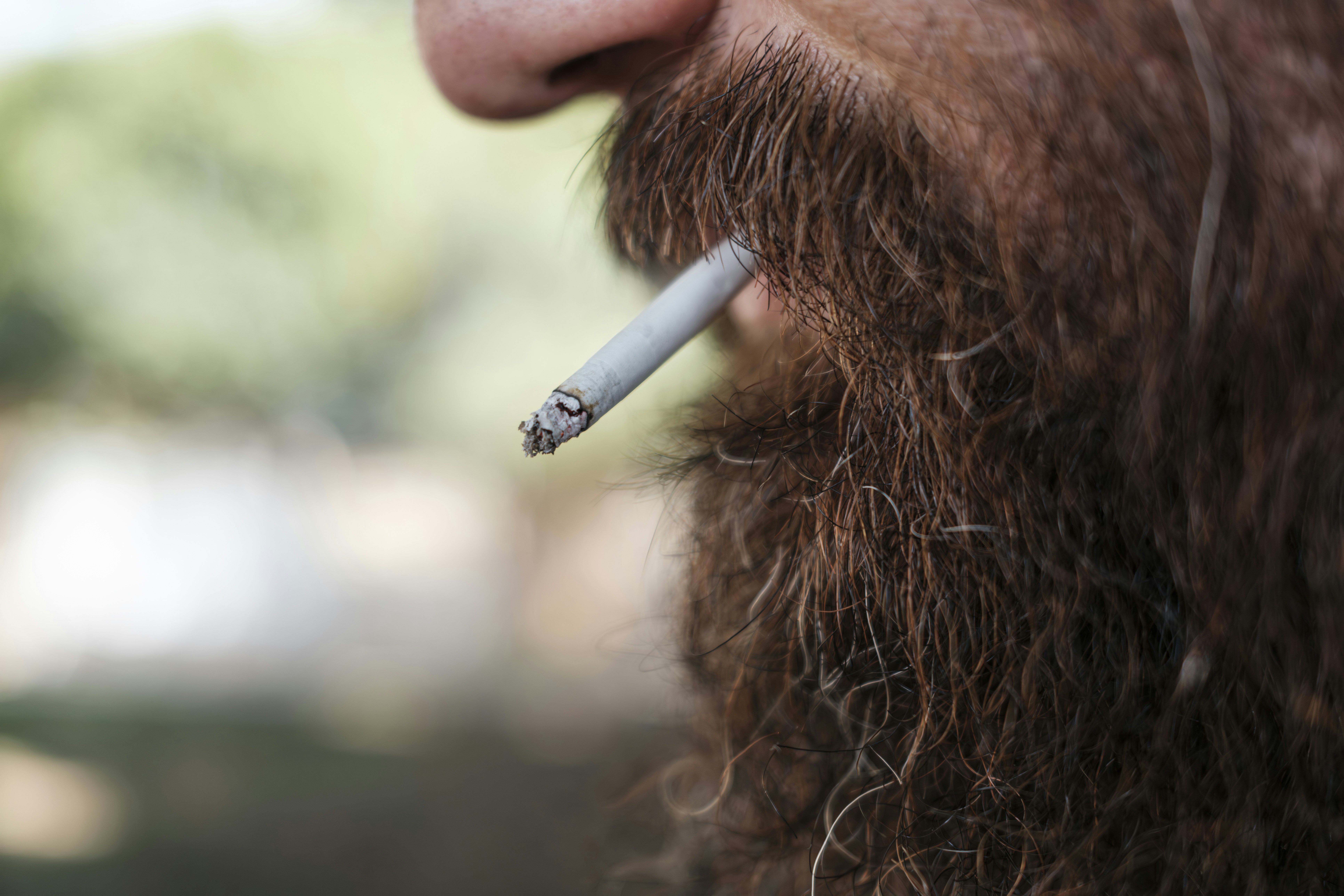 Man with beard smoking a cigarette photo – Free Portrait Image on Unsplash