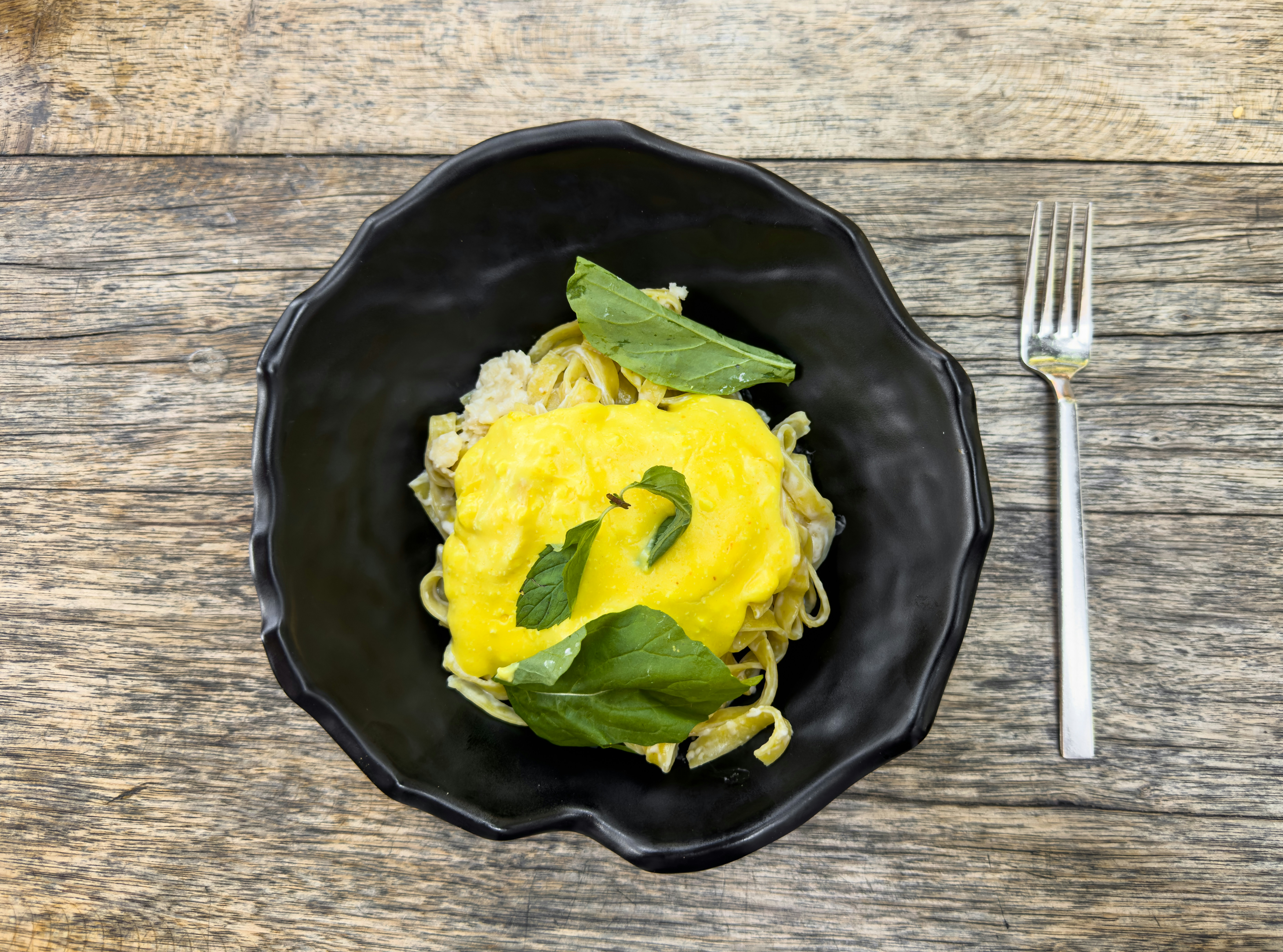 italian pasta dish with cheese | Pasta dish with yellow sauce and green leaves