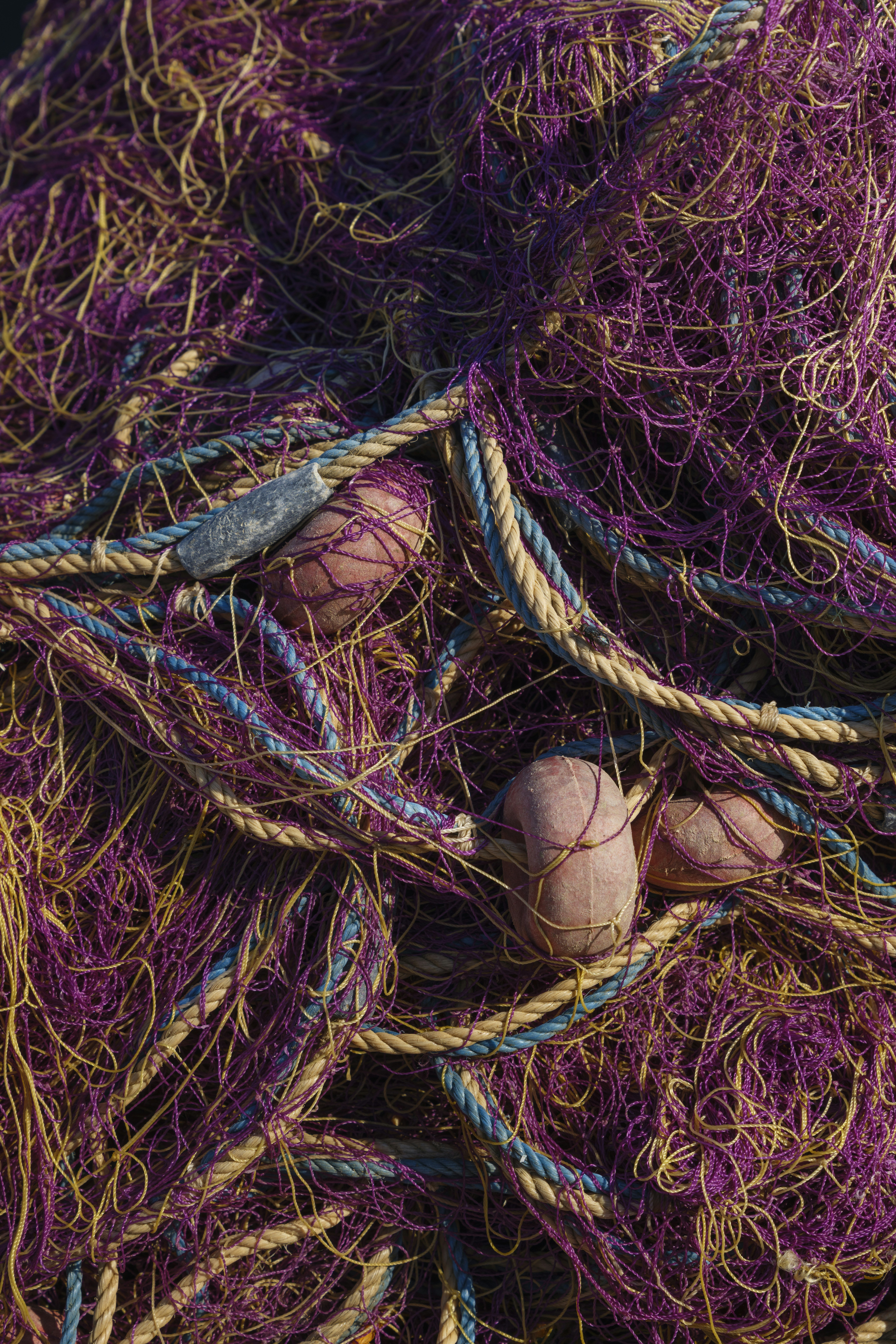 detailed view of fisherman's net | Pile of tangled fishing nets with buoys and ropes