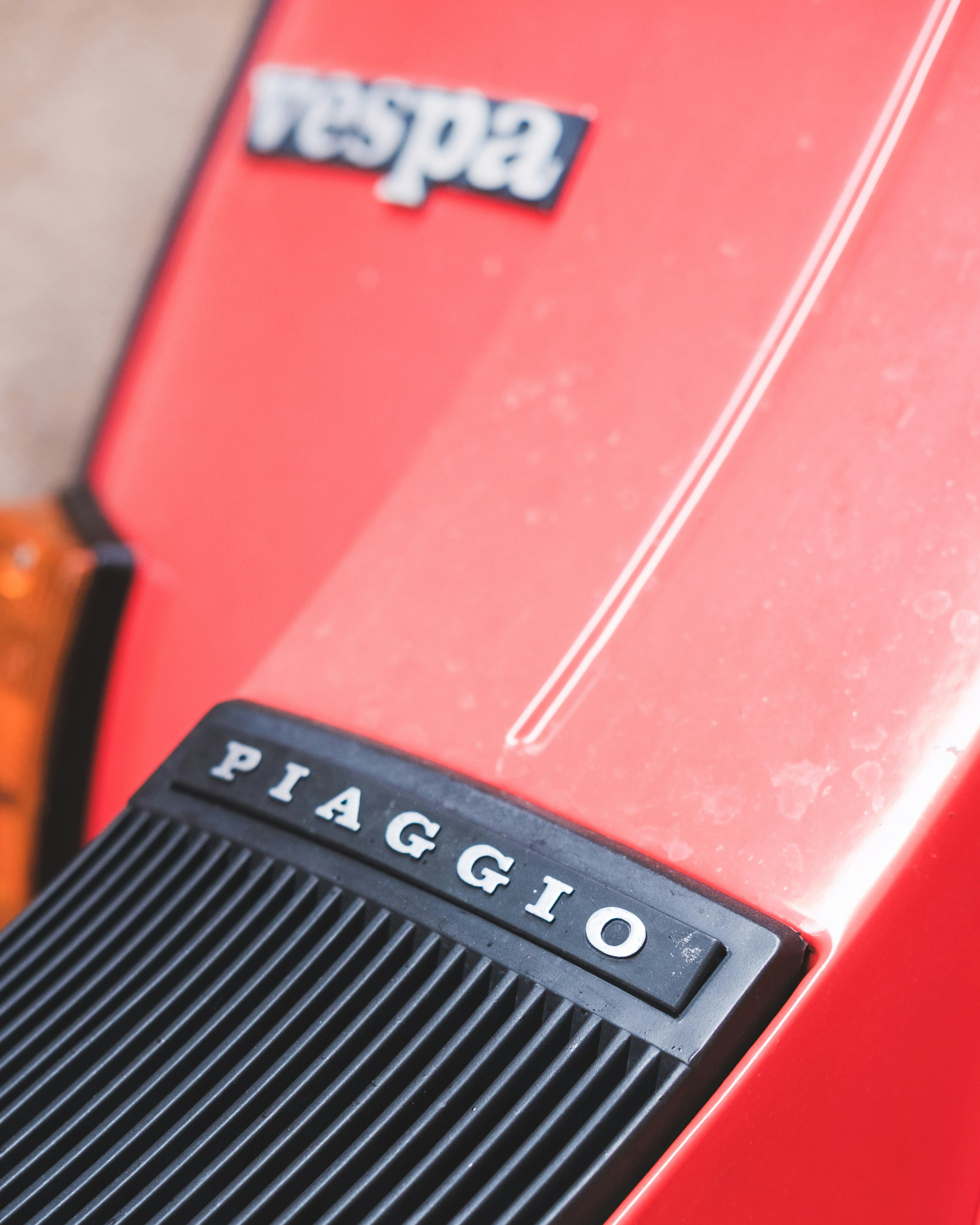 Piaggio Vespa in Red | Red vespa scooter with piaggio logo detail