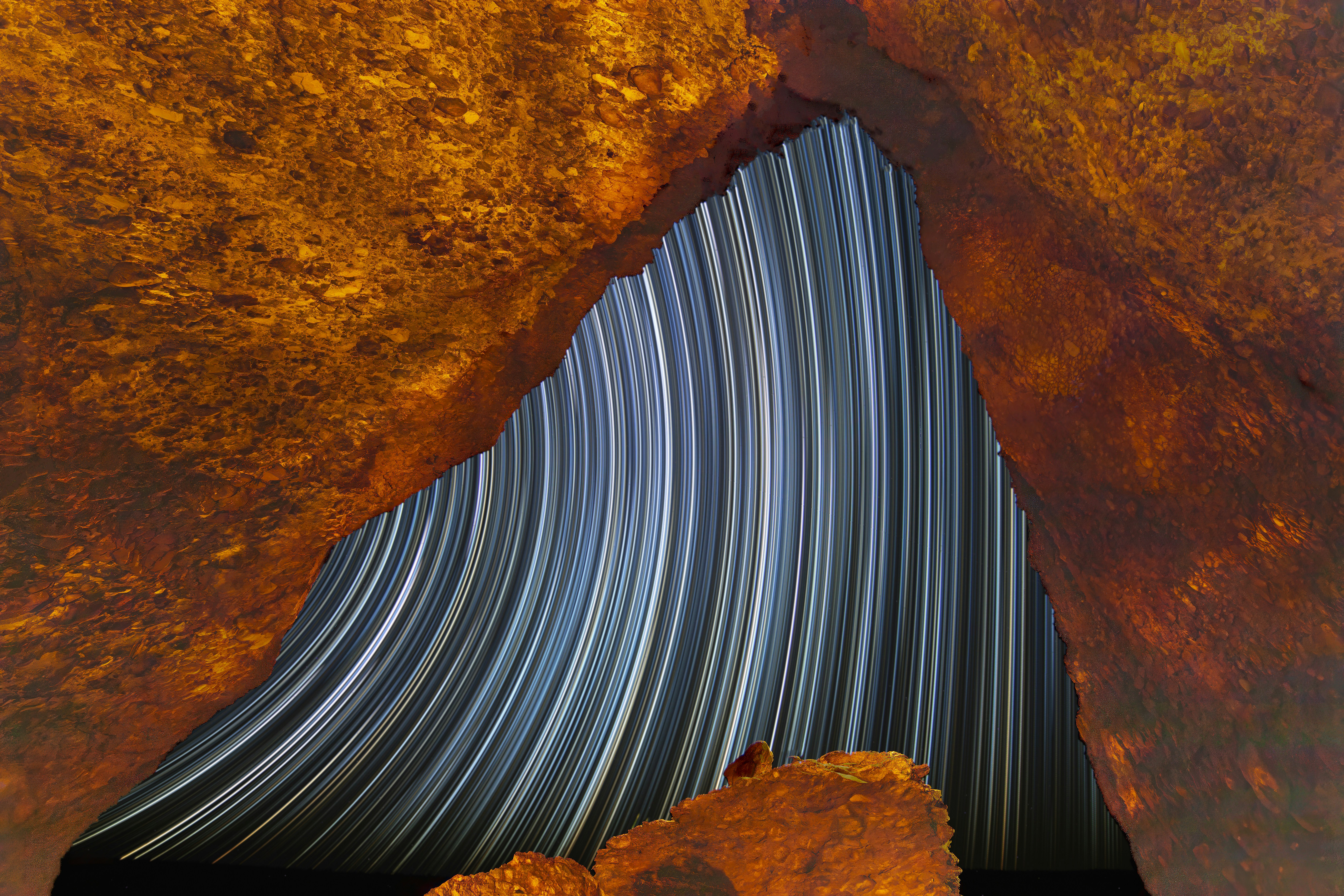 Celestial Dance Through Rocky Archways