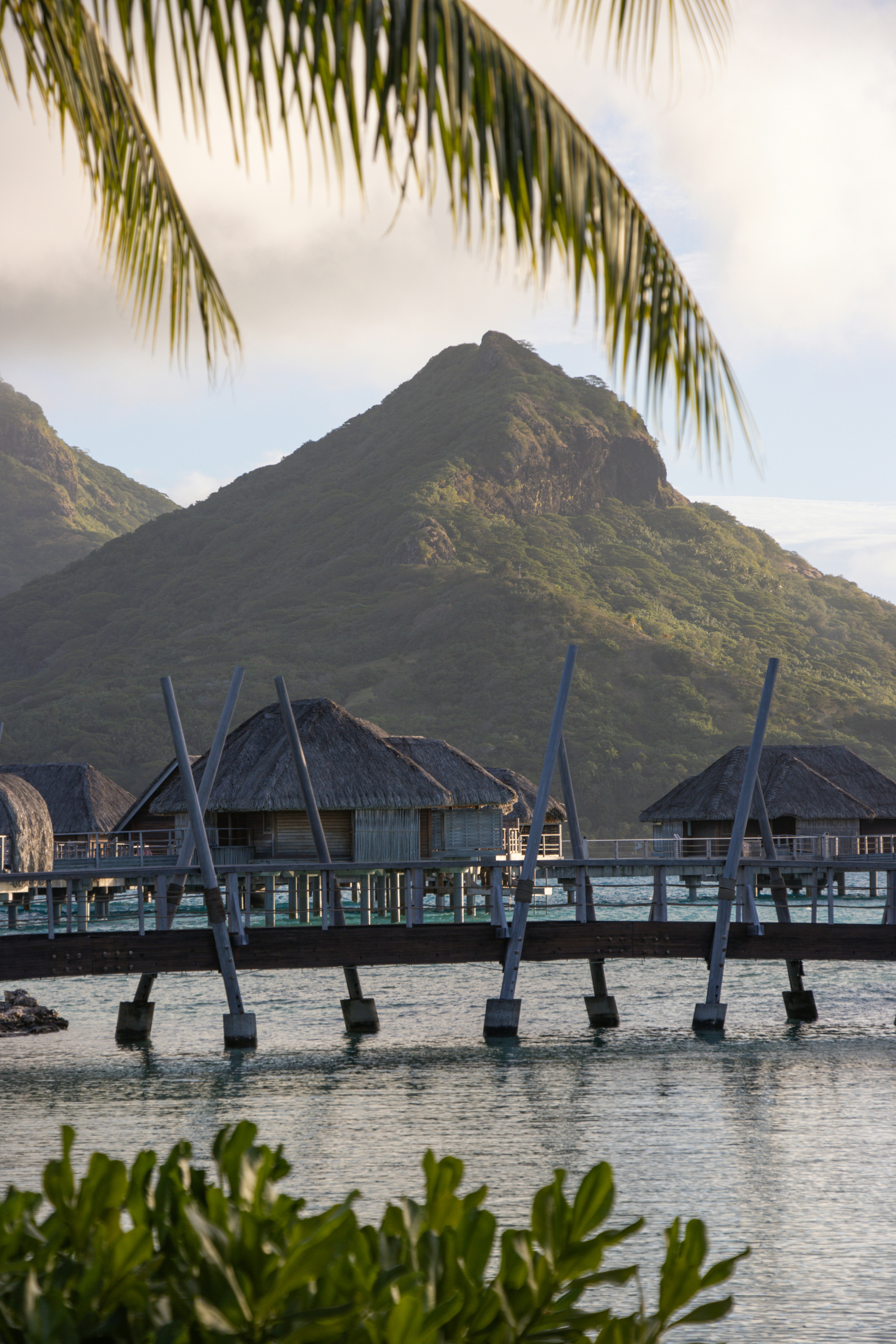 Overwater Haven: Mountain Peak Beyond the Pier