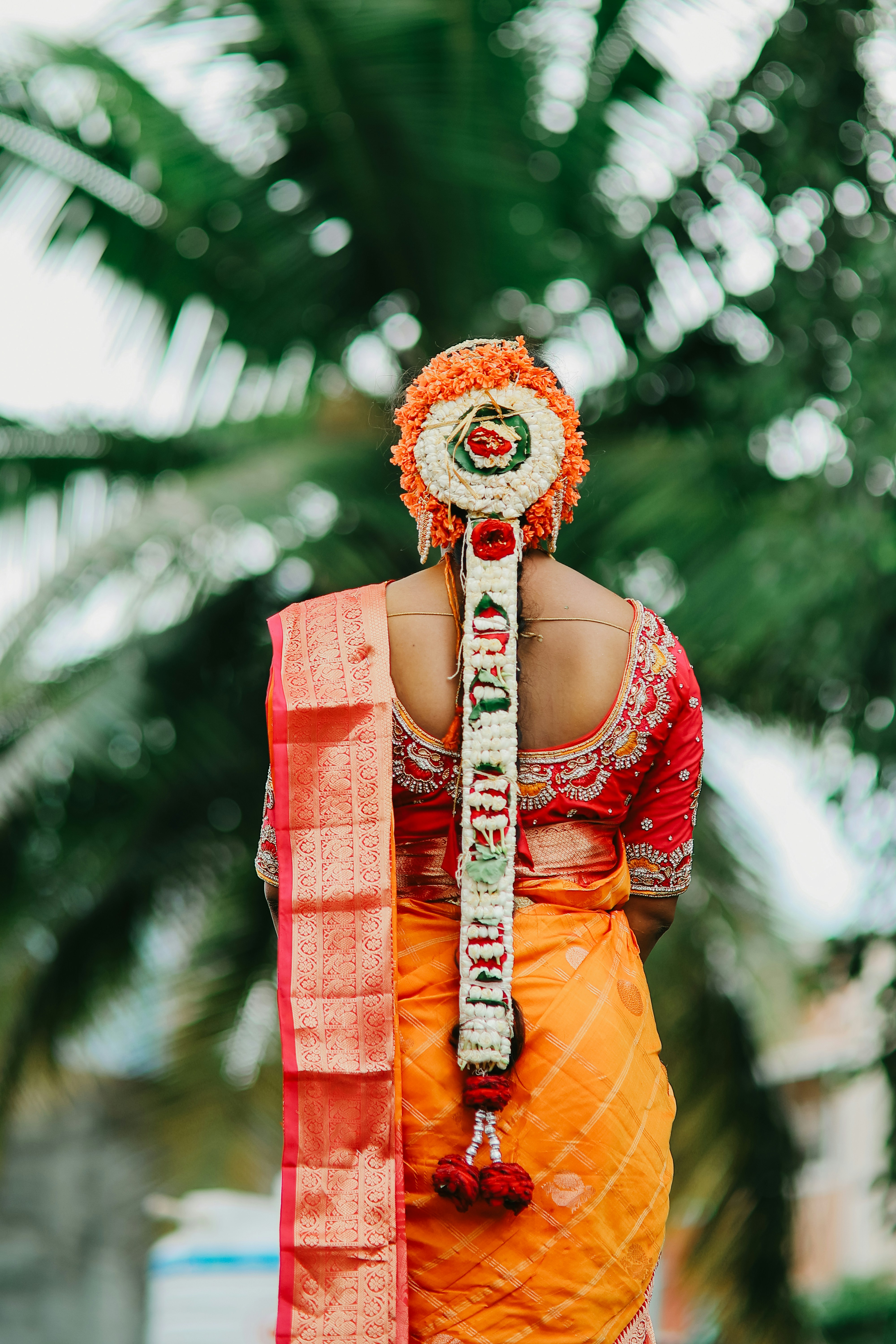 Garlanded Silk: Bride's Back in Orange with Floral Trail among Tropical Palms