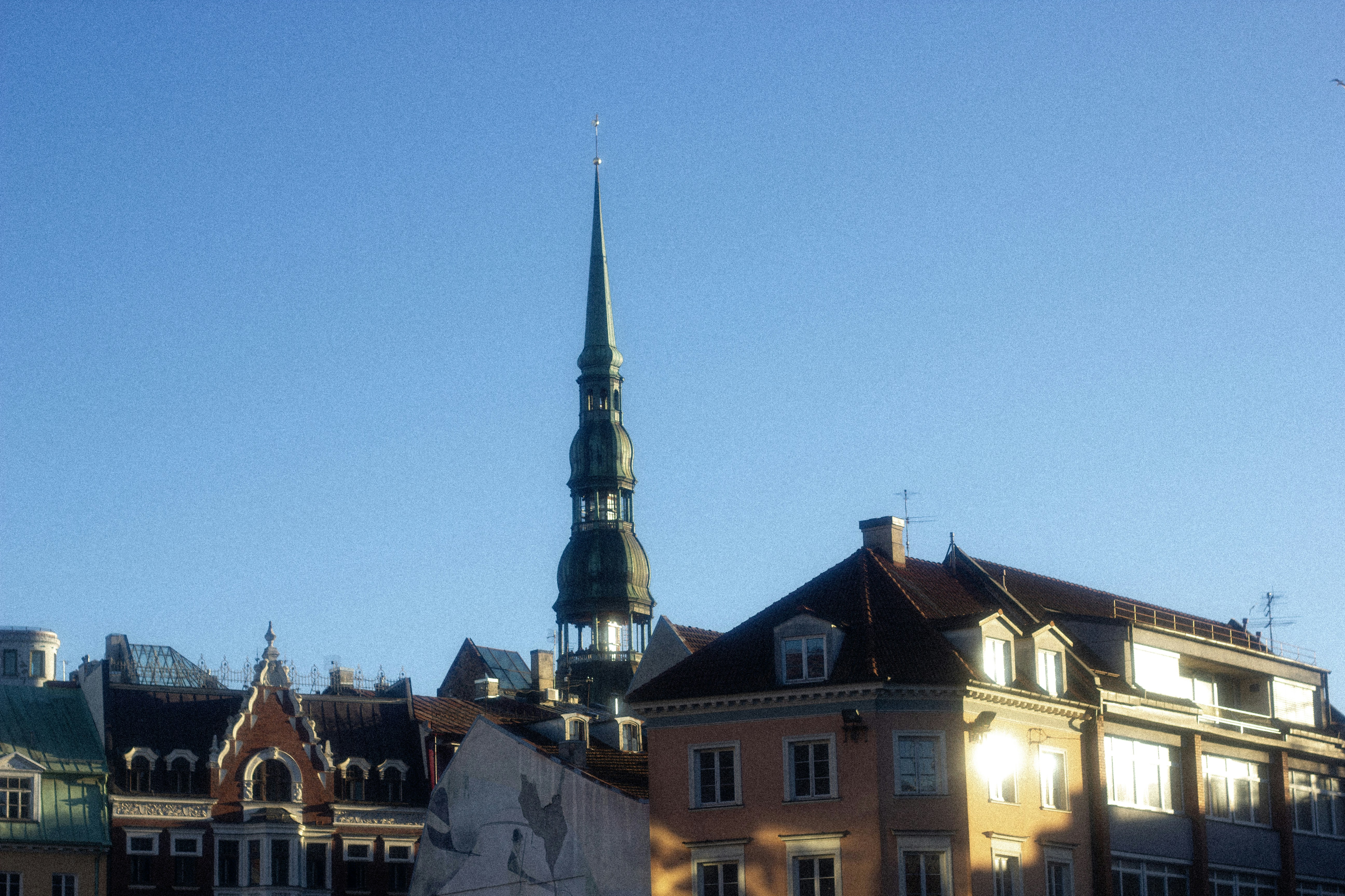 Tall church steeple against a clear blue sky.