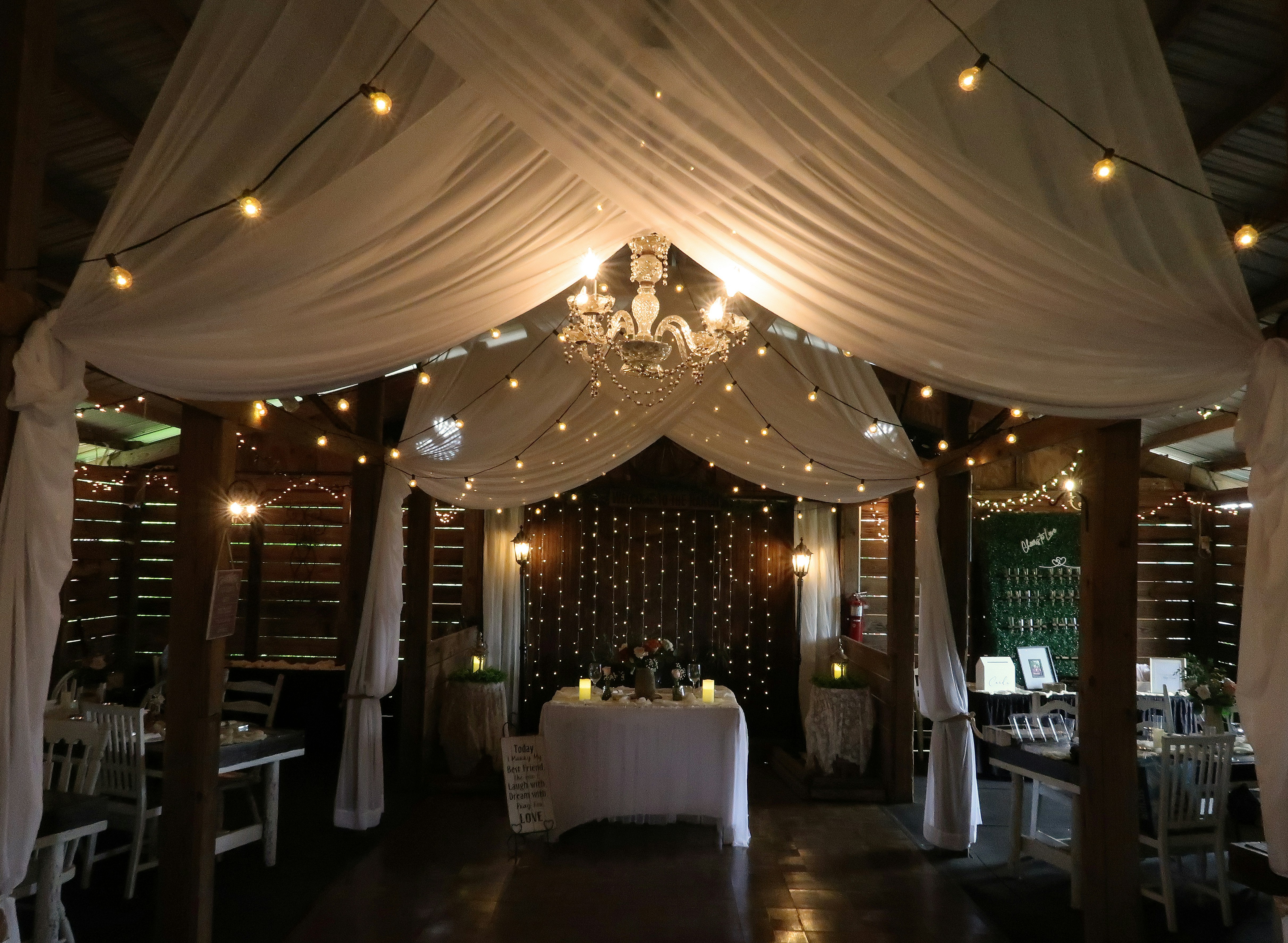 Elegant wedding reception venue with draped fabric and lights