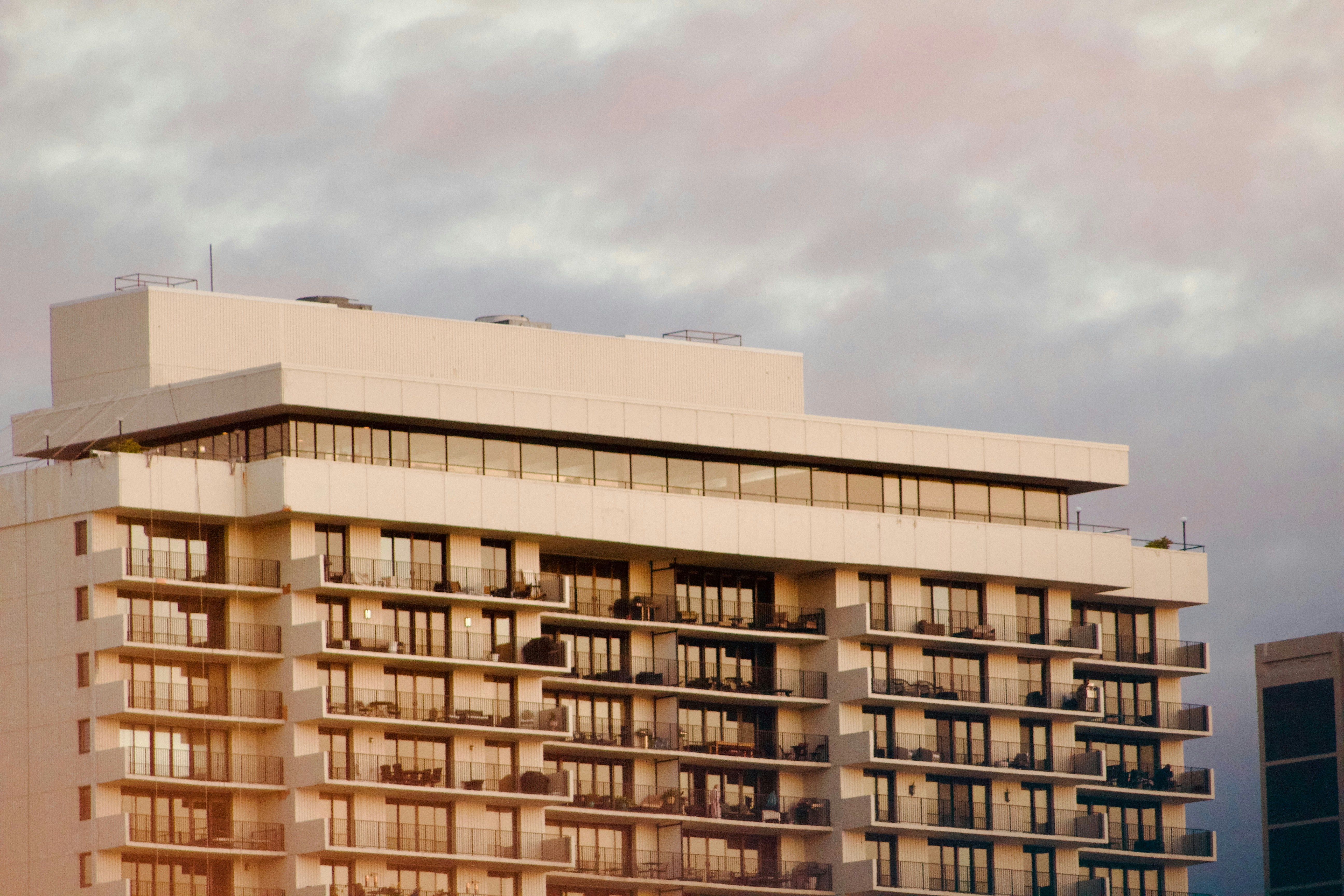 Lake shore drive sunrise views | Modern hotel building with balconies against cloudy sky