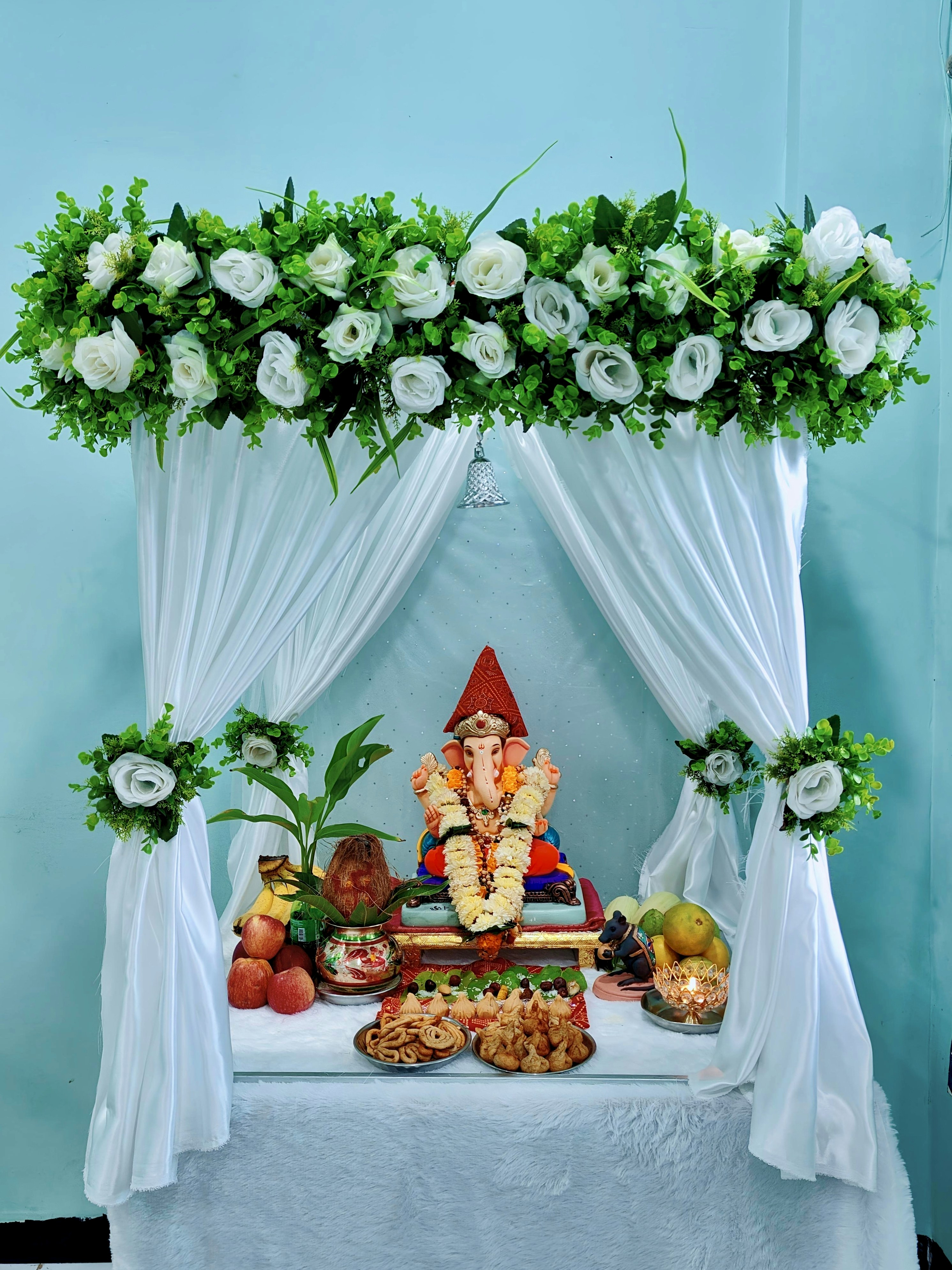 Garlanded Ganesh Altar Beneath Flowing White Drapes