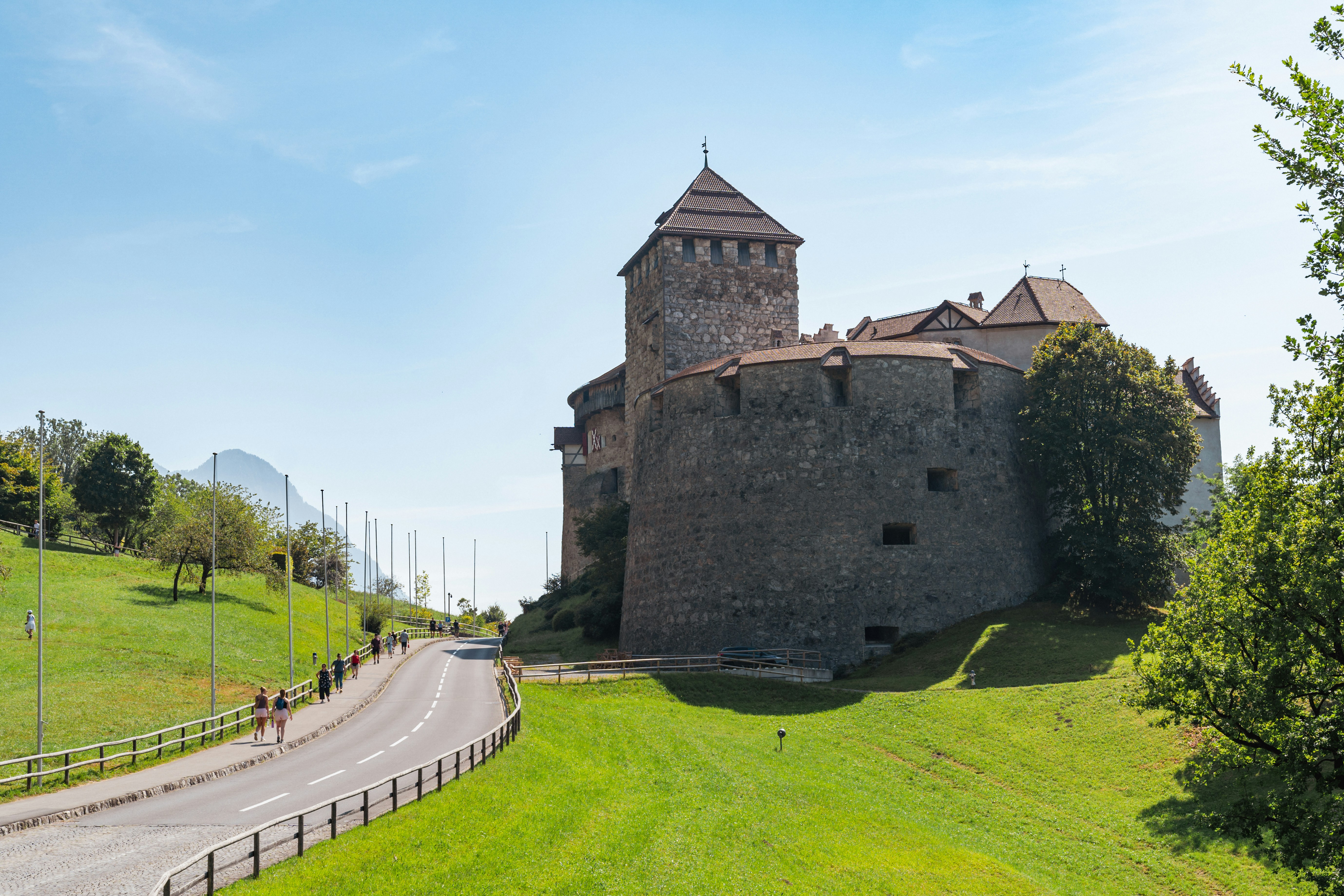 Vaduz, Liechtenstein | Stone castle on a grassy hill under a blue sky