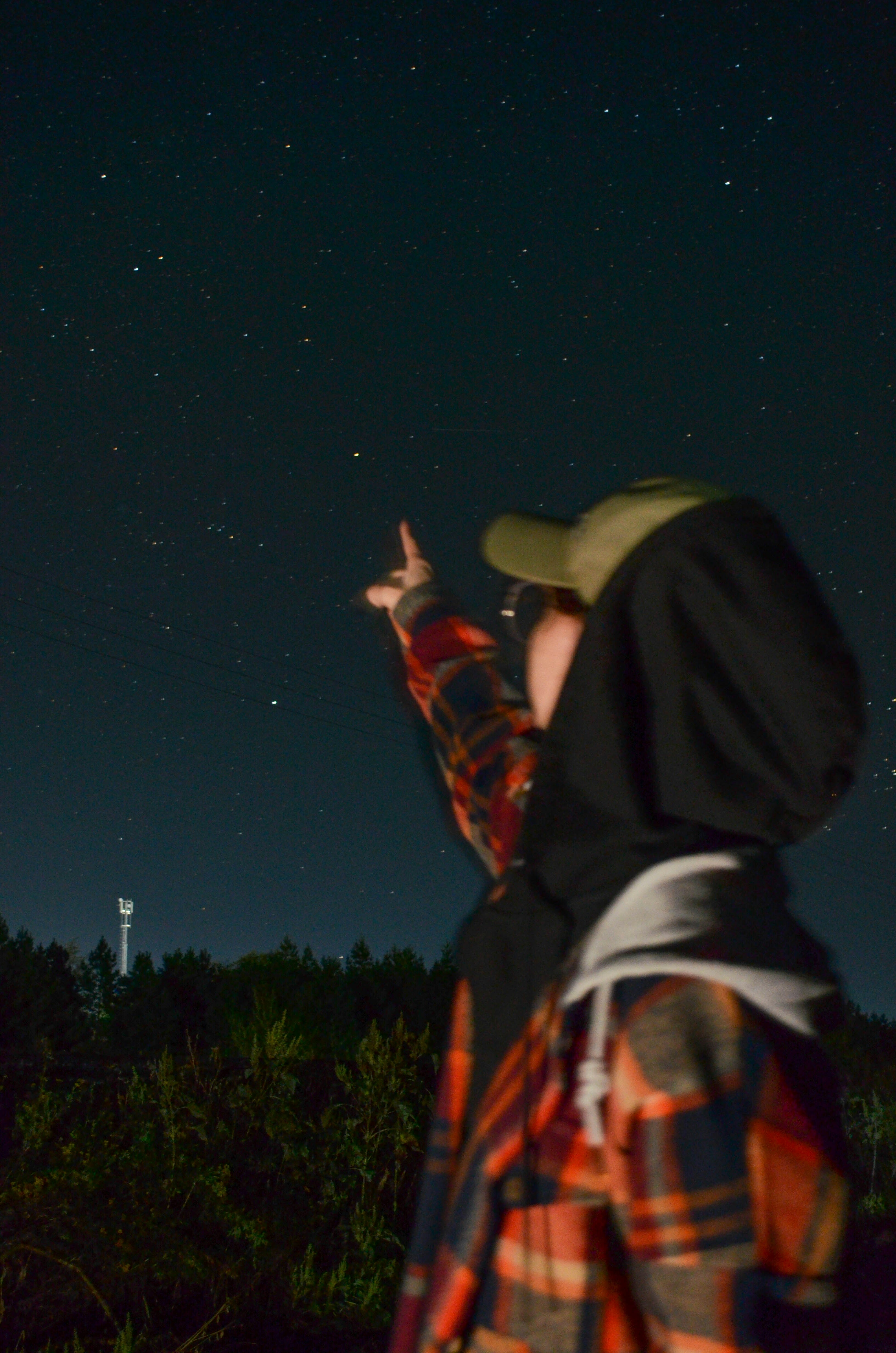 Guided by the Night: A Plaid-Clad Figure Reaches Toward the Stars