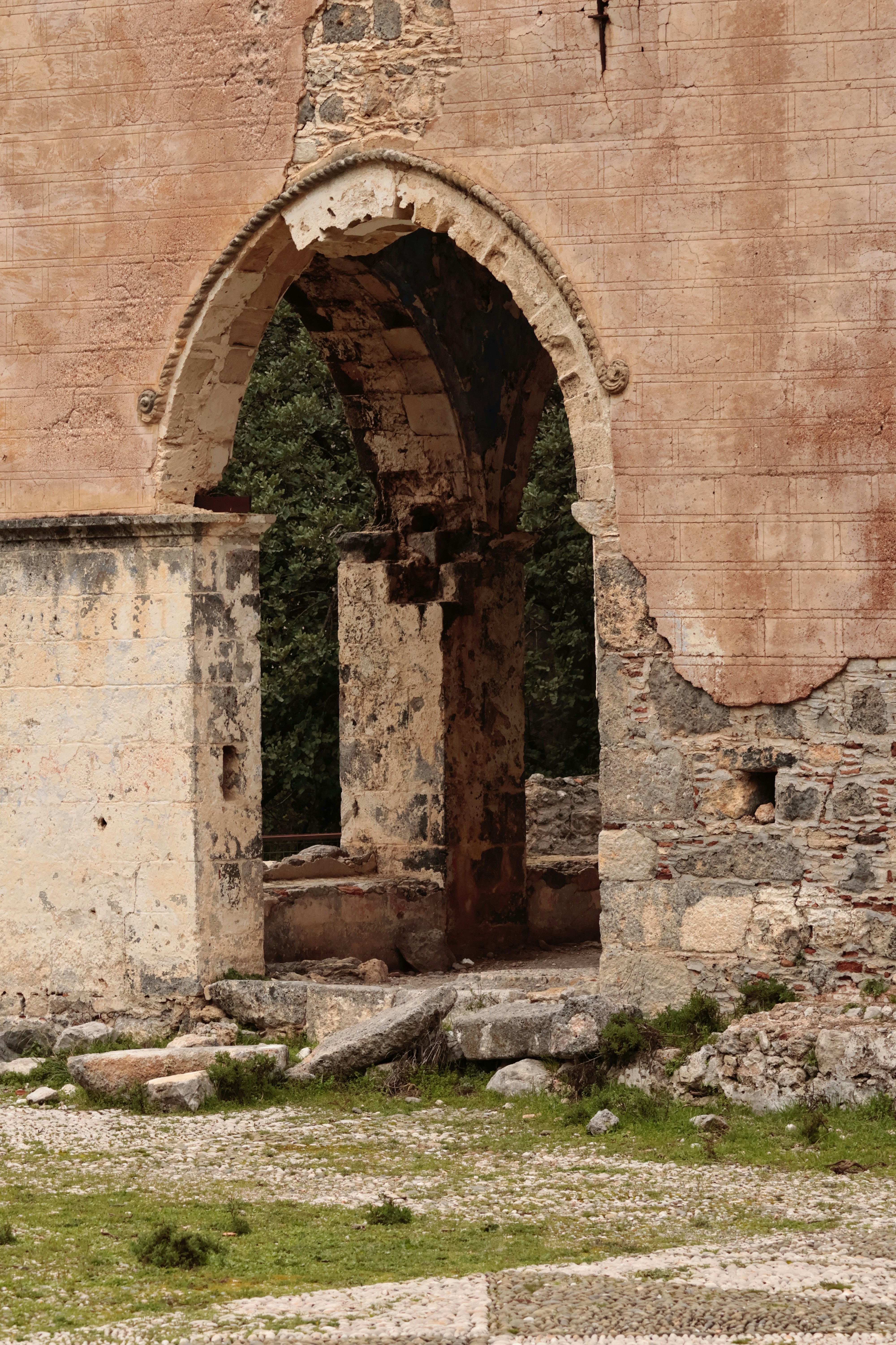 Ancient stone archway in a weathered, ruined building
