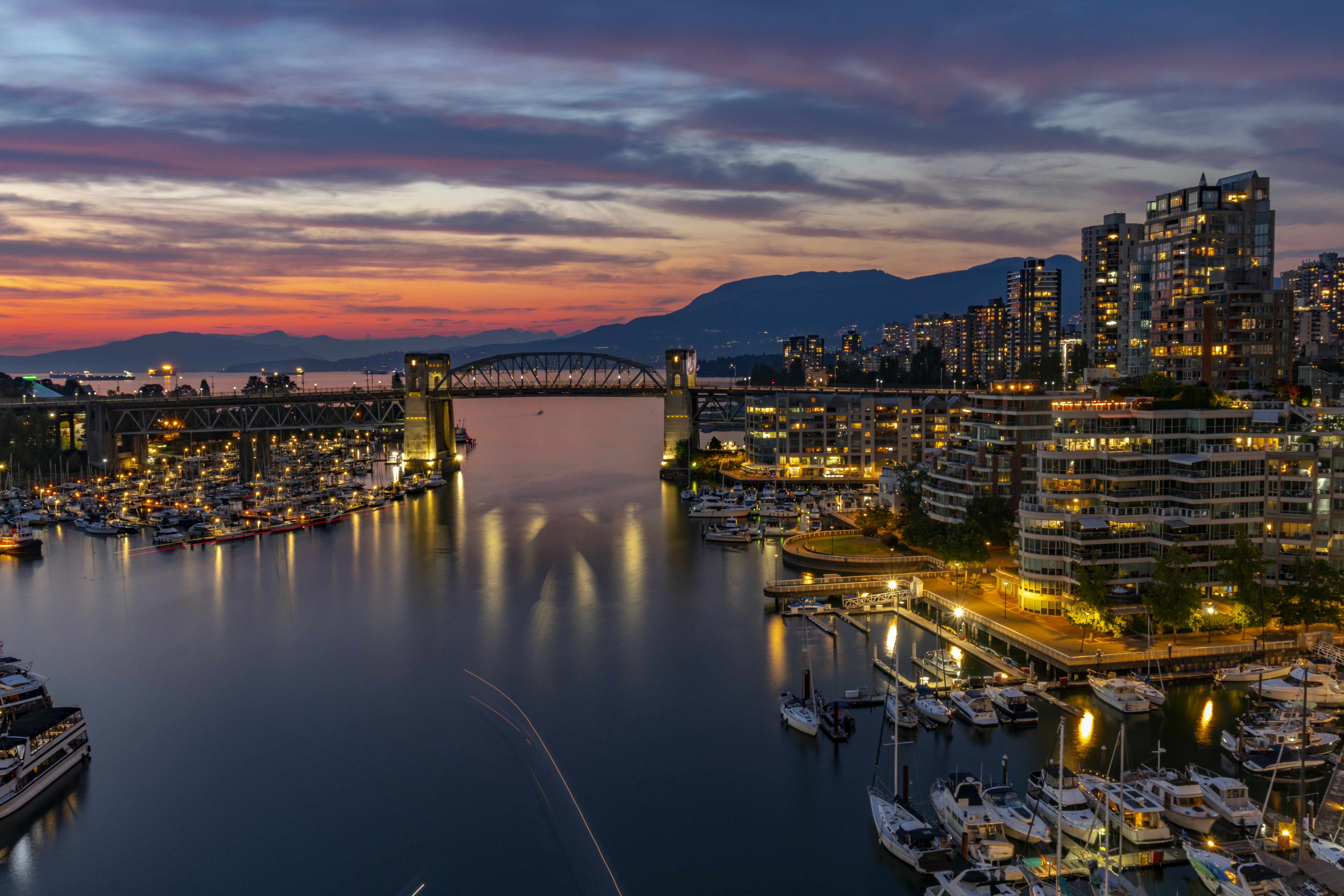Canada Vancouver Burrard Street Bridge and downtown West End view of False Creek Sunset Sky | Cityscape with bridge and harbor at dusk
