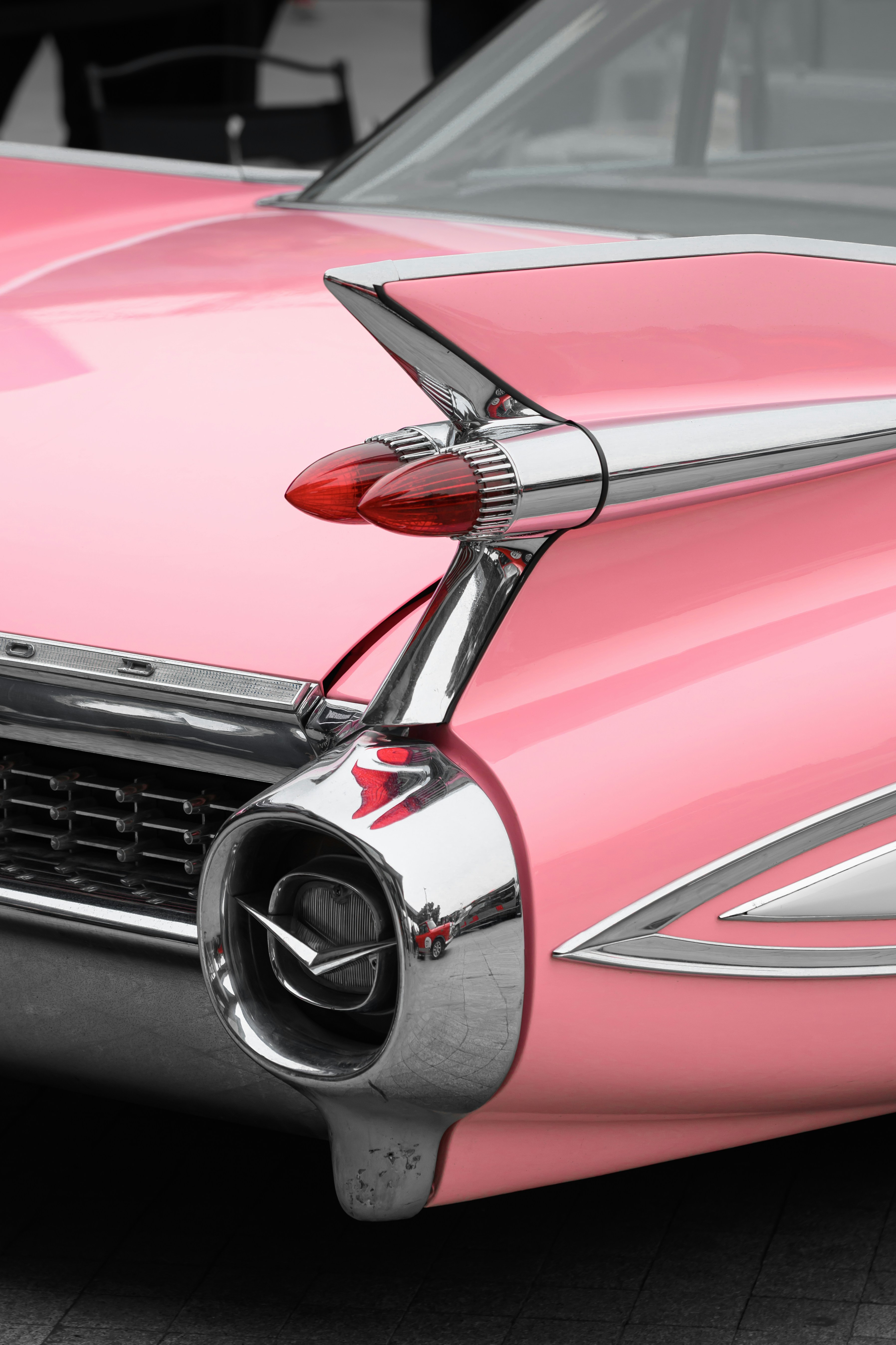 Pink chrome tailfin close-up: mid-century automotive sculpture