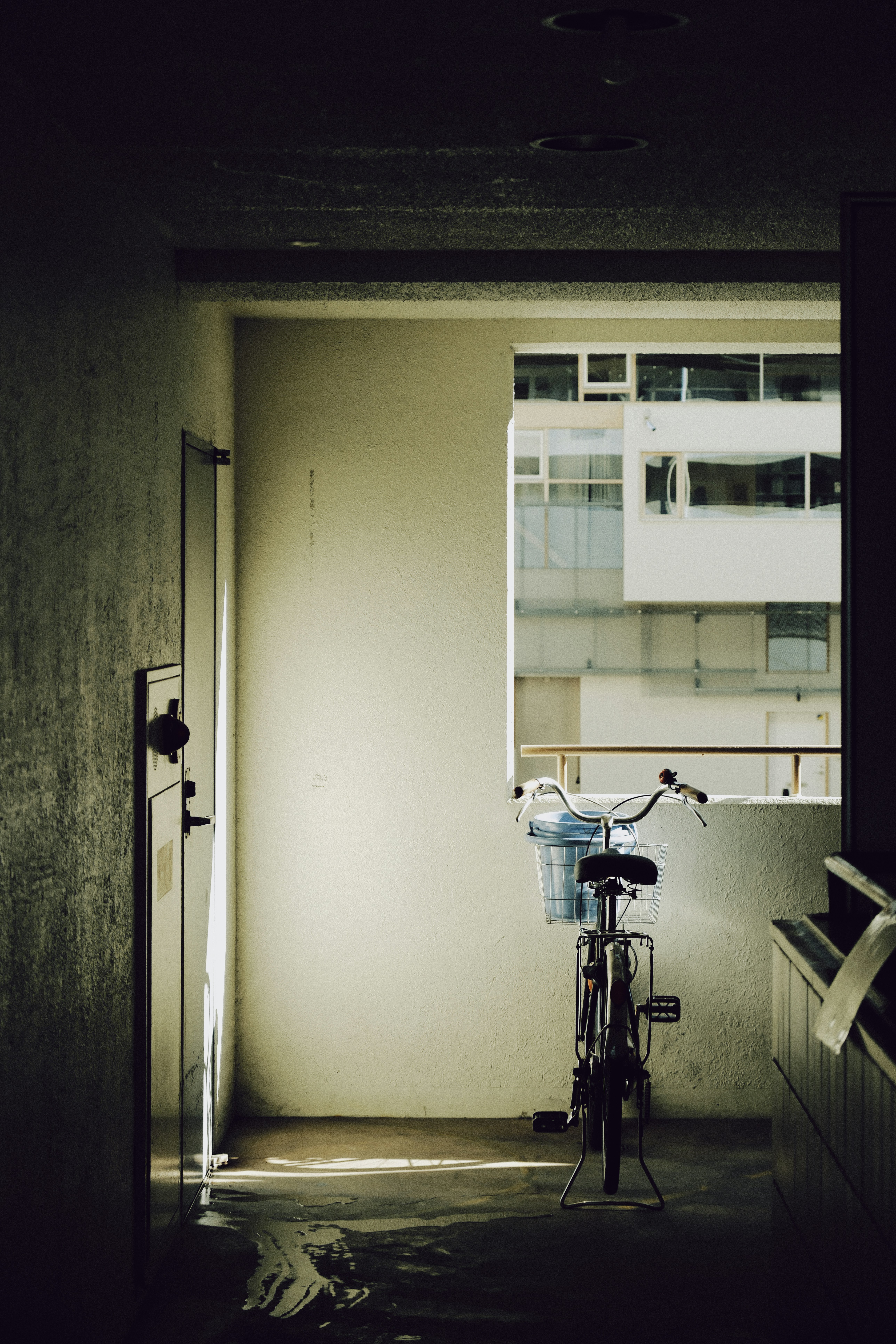 Bicycle with basket on balcony in sunlight
