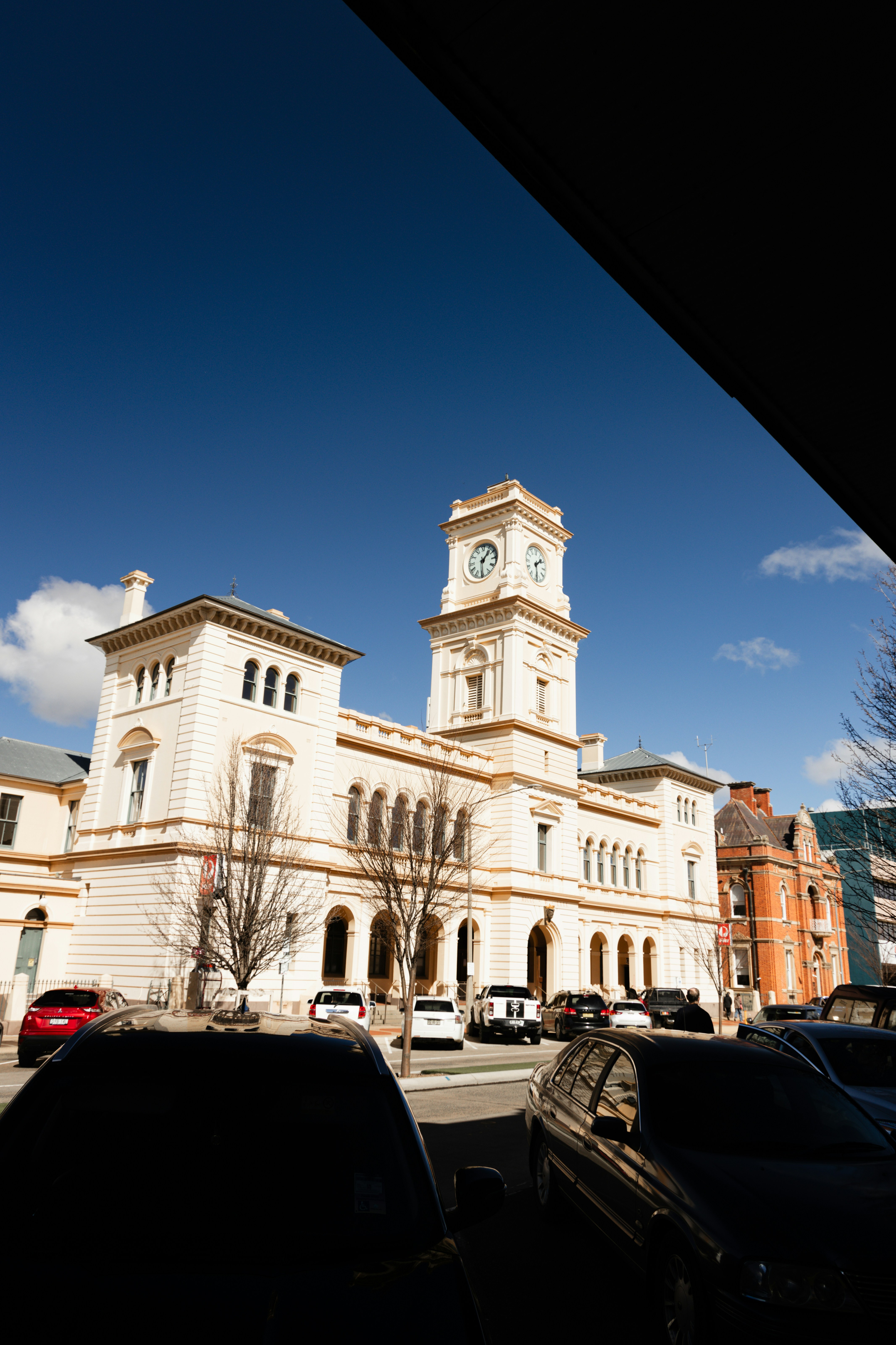 Ornate building with a clock tower under a blue sky.