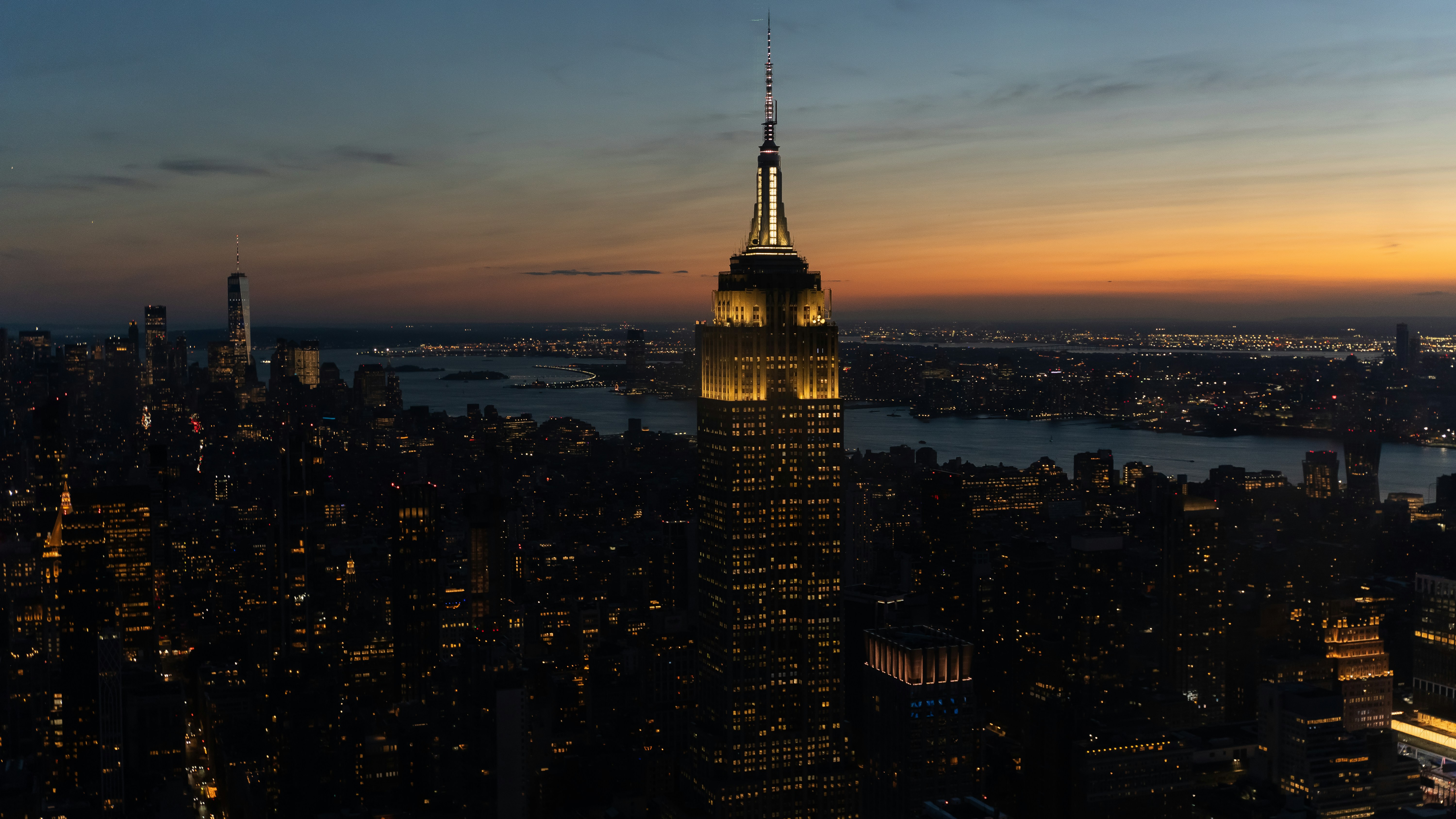 City Crown at Dusk: Empire State Silhouette Over the Quiet River