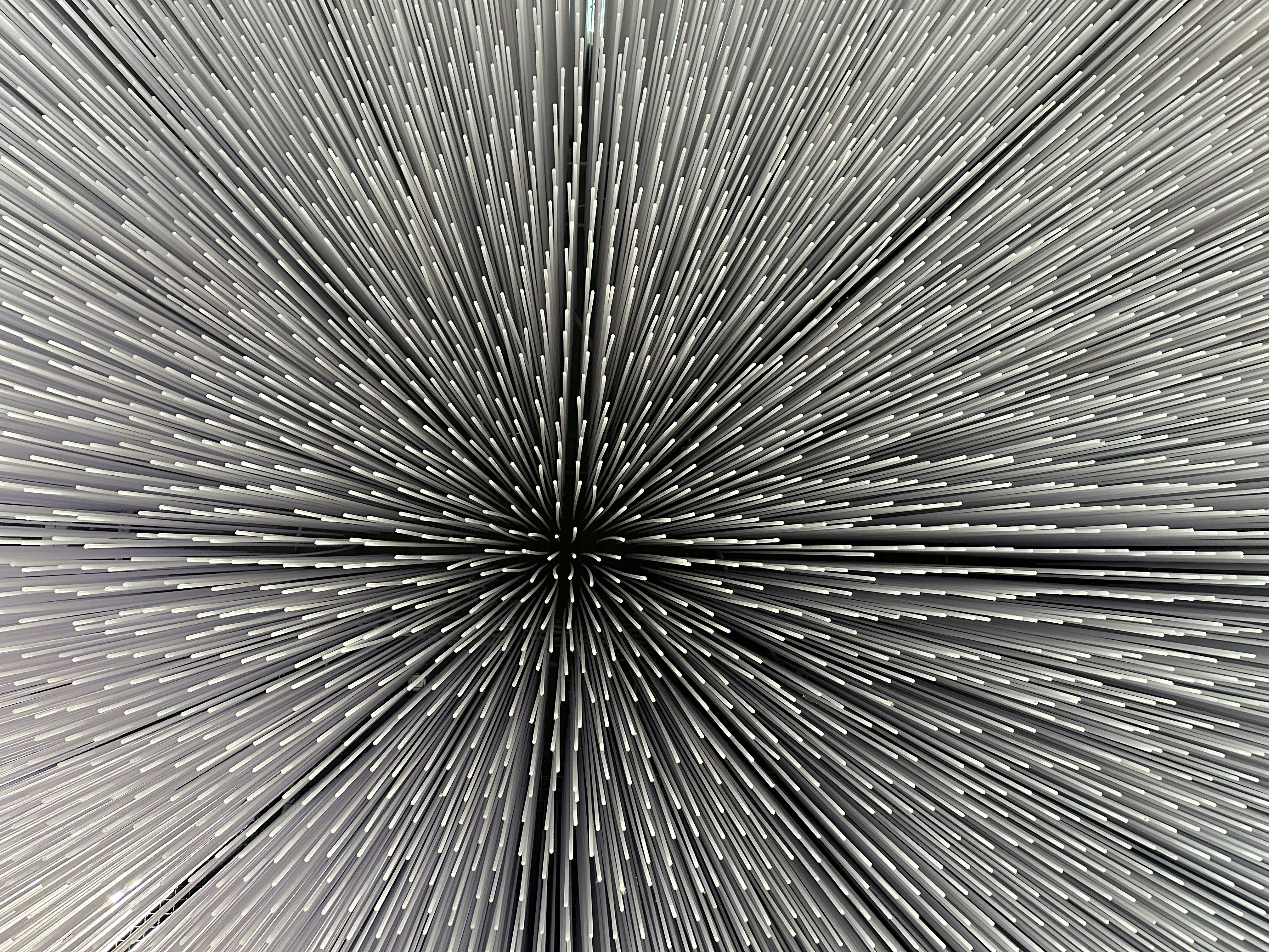 Abstract pattern of thin white lines radiating outwards.