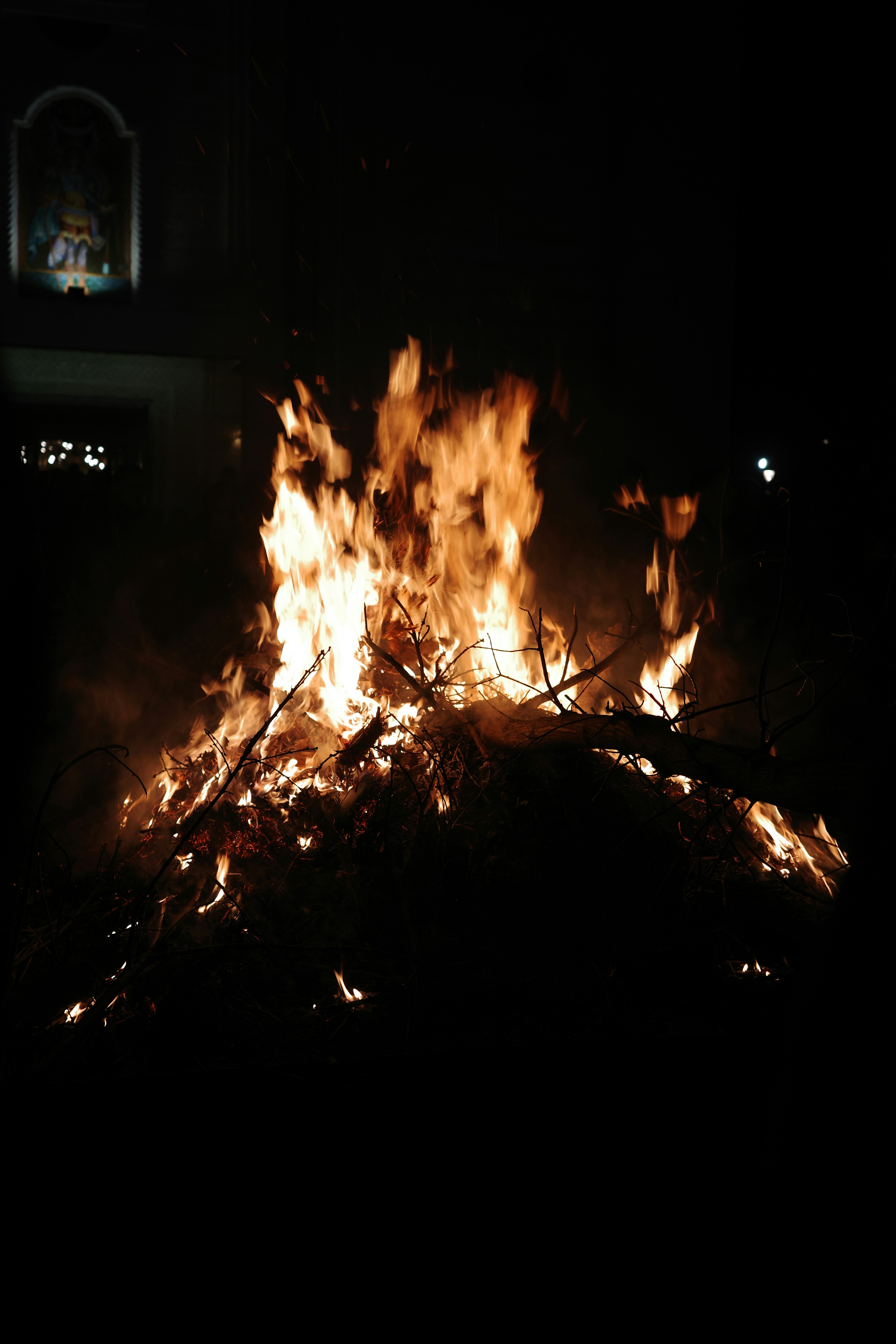 A large bonfire burns brightly at night.