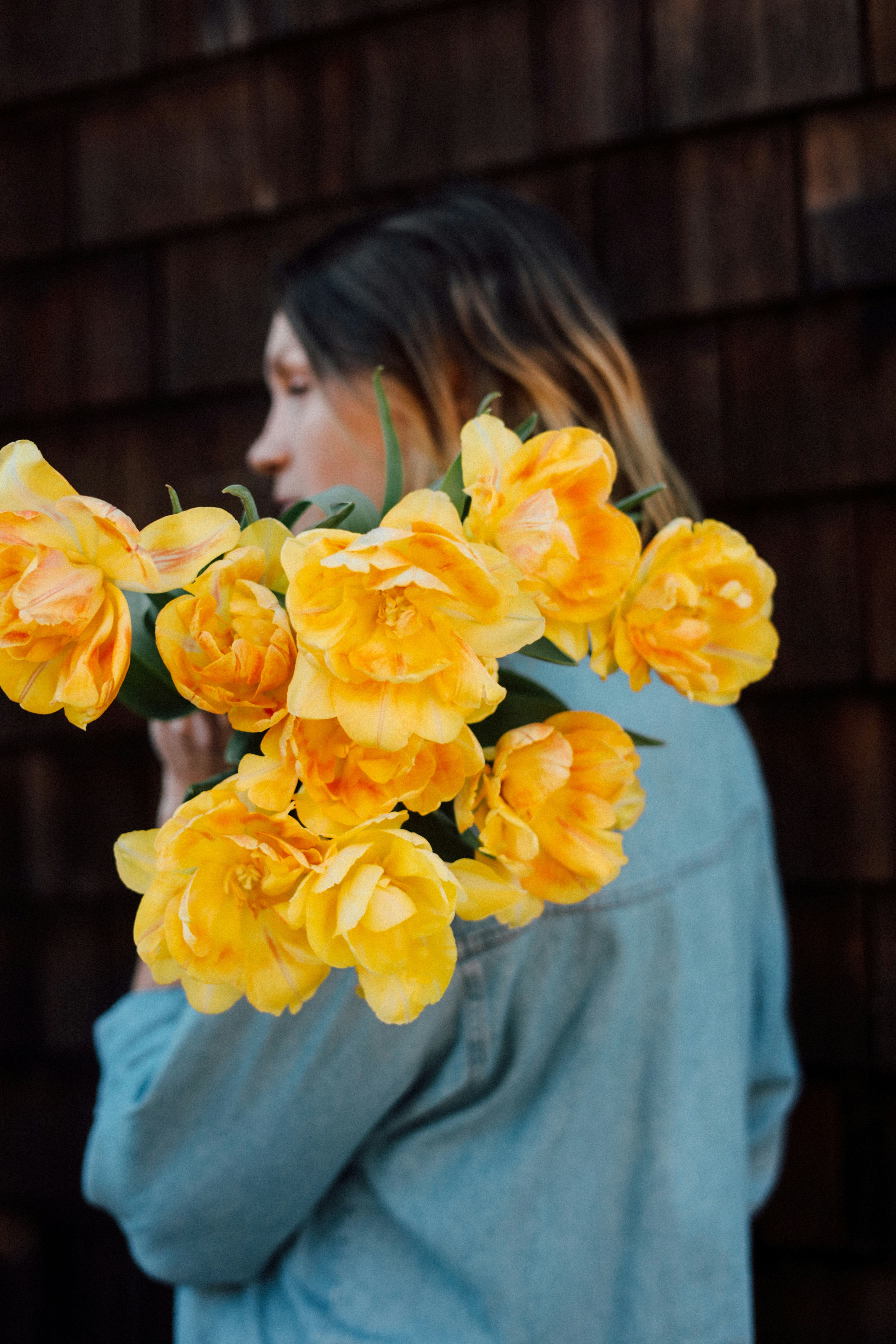 Woman holding a bouquet of yellow tulips