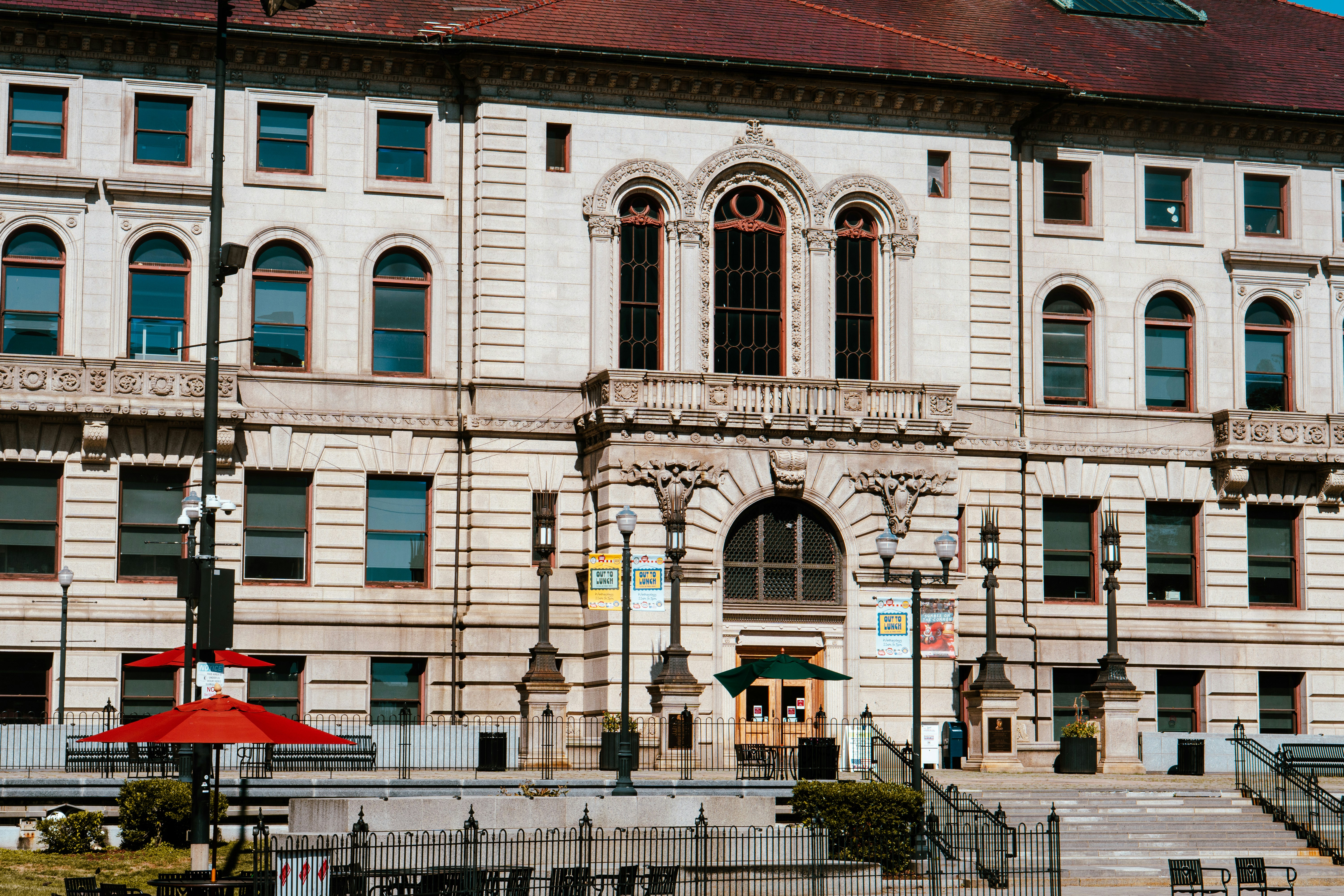 City hall photography | Ornate stone building with arched windows and entrance.